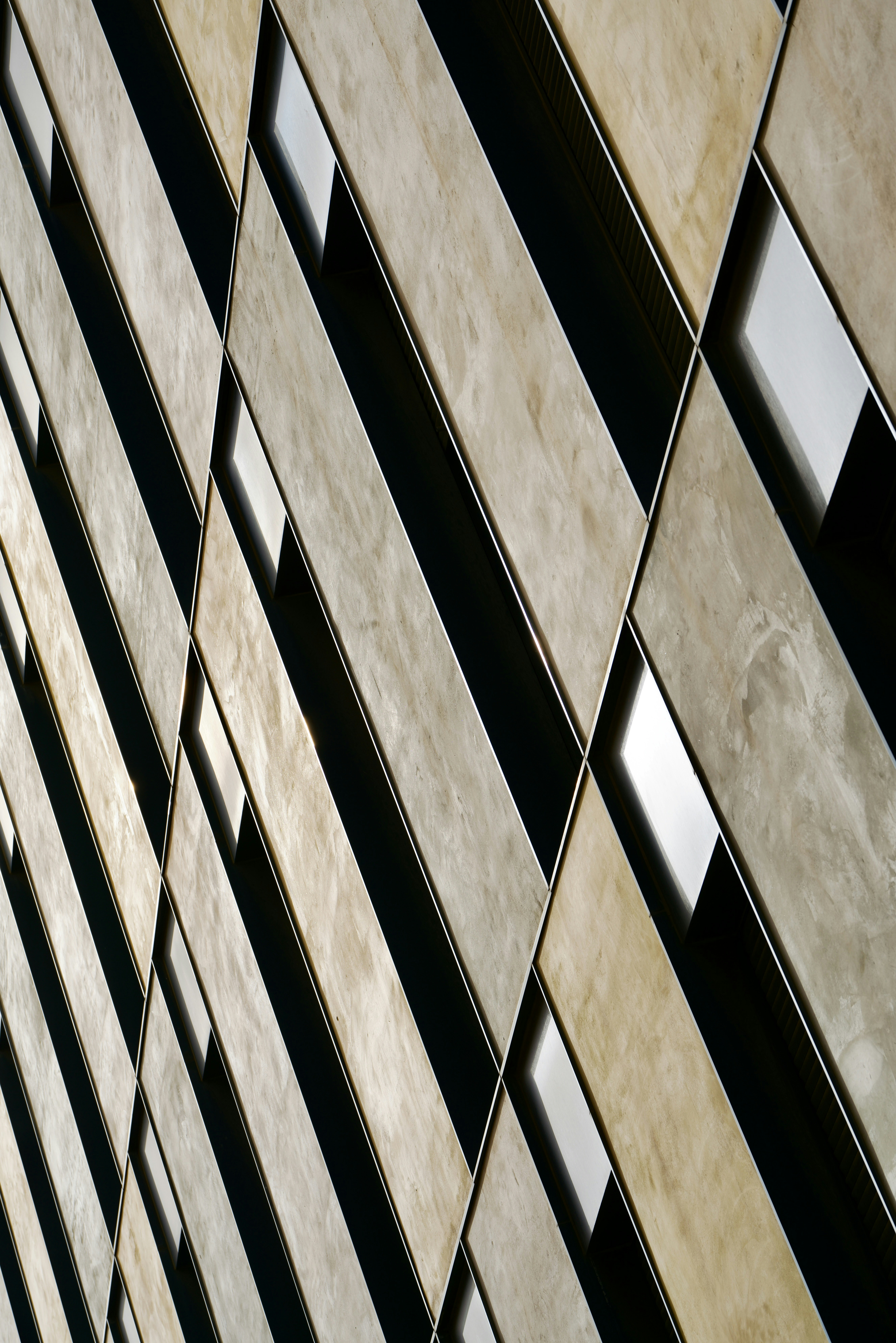 Diagonal Facade: Intersecting Strata of Stone and Shadow