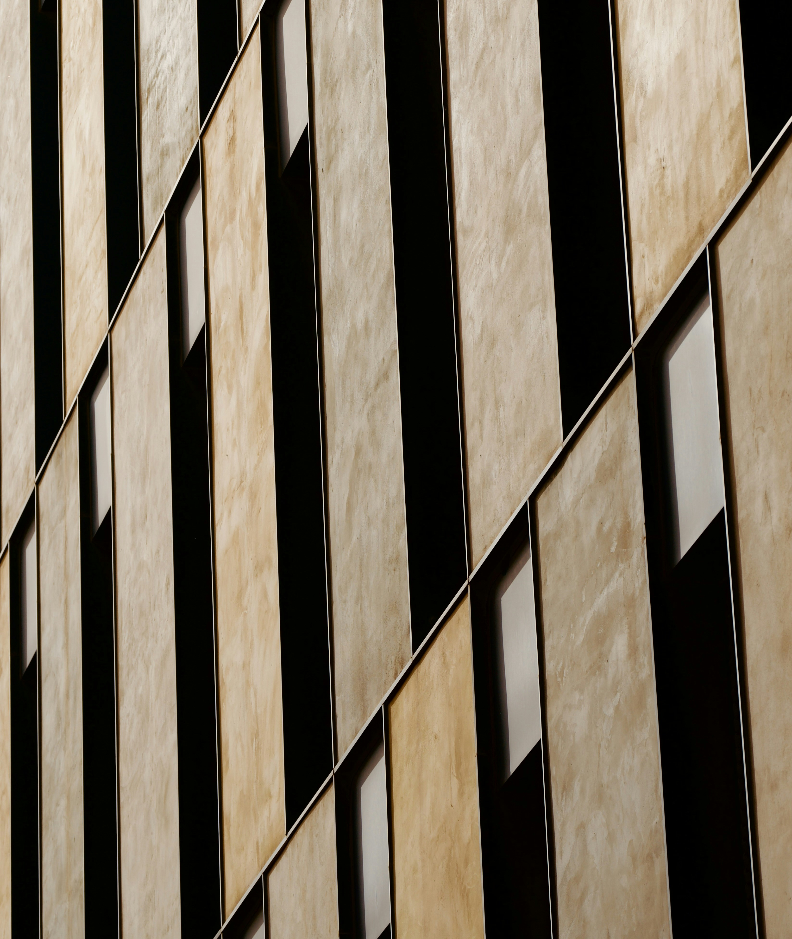 Diagonal Facade: Golden Panels and Shadowed Cracks