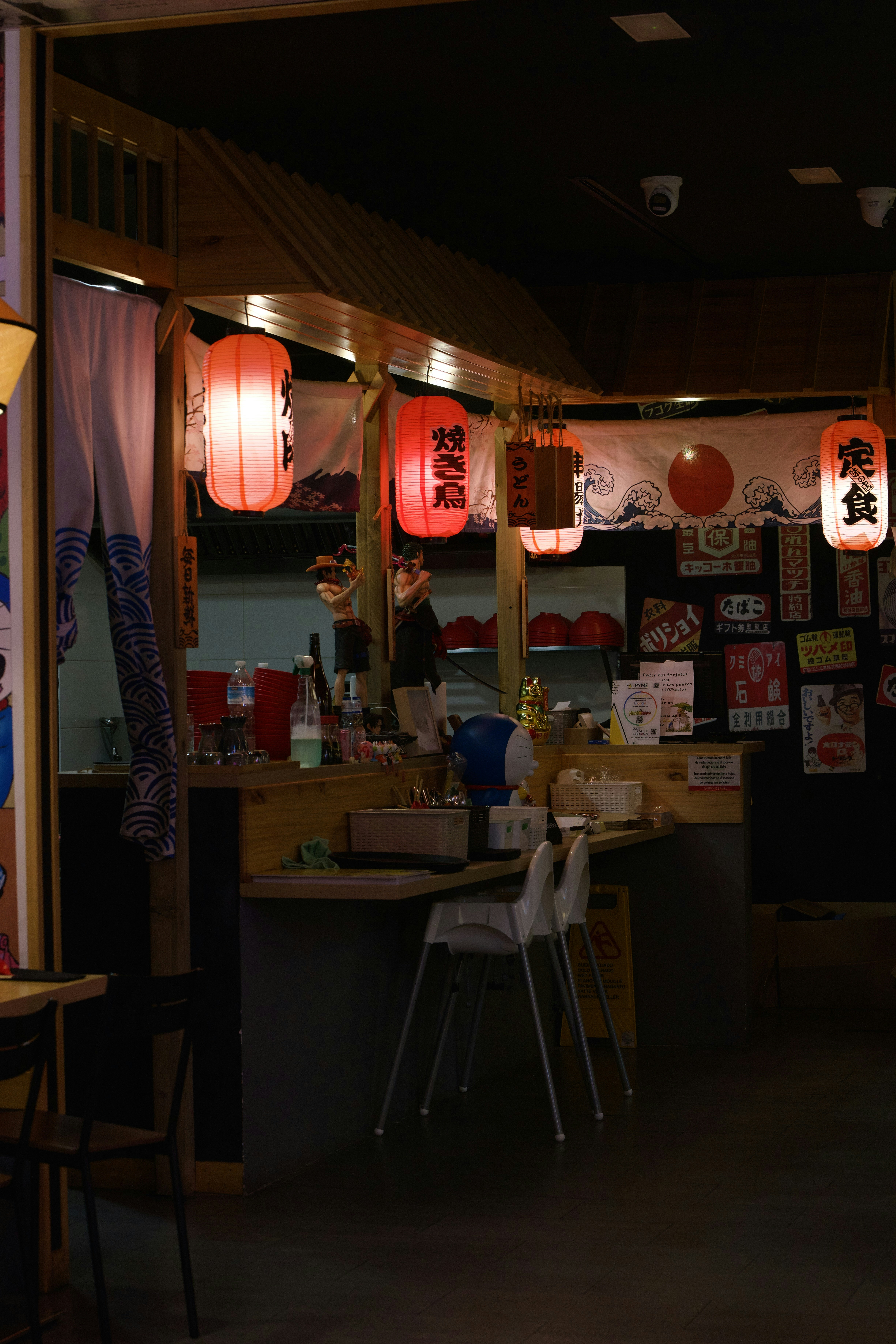 Red Lanterns and Bistro Lights Over a Quiet Japanese Eatery