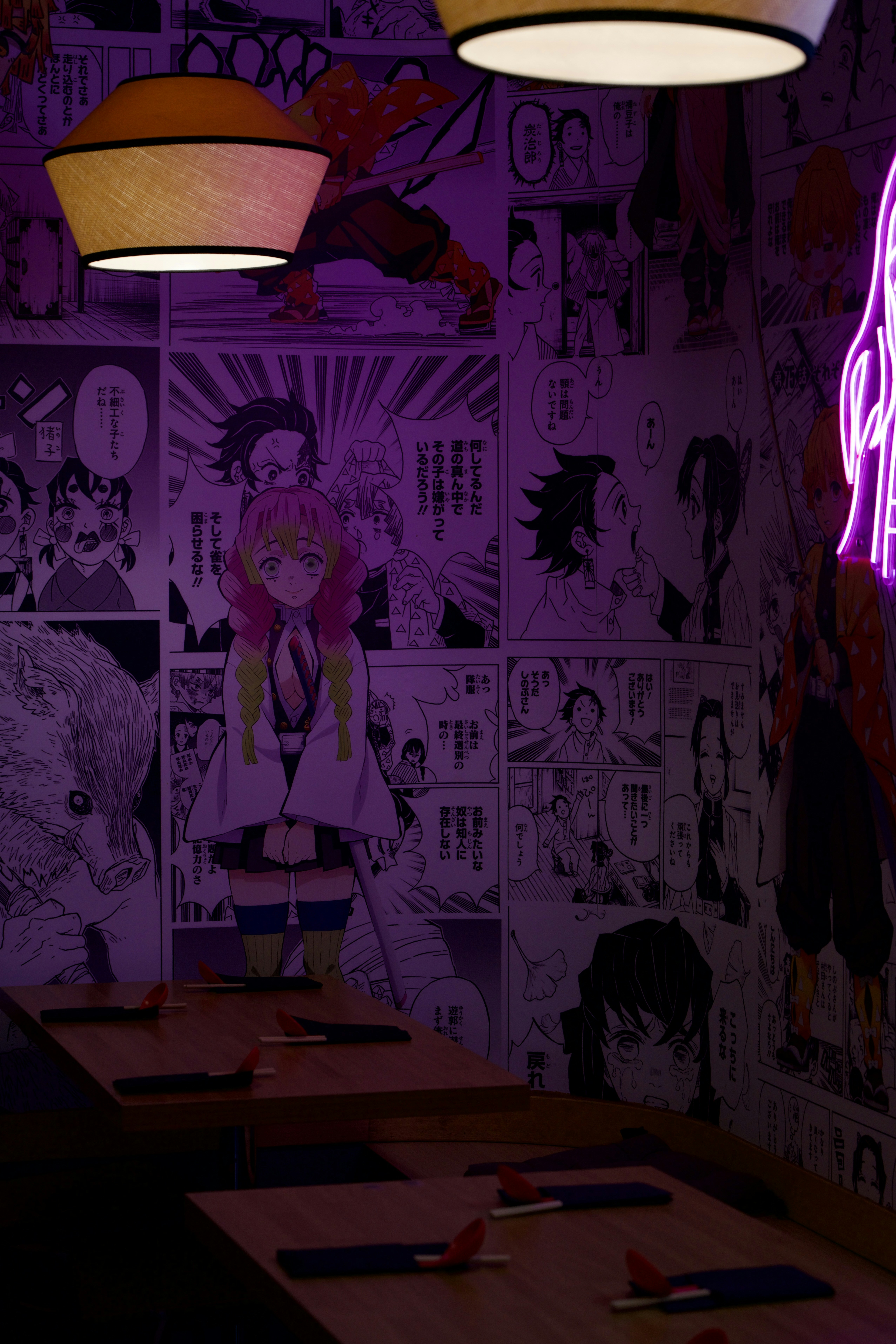 Neon Manga Corner: a girl in a cafe wallpapered with comics