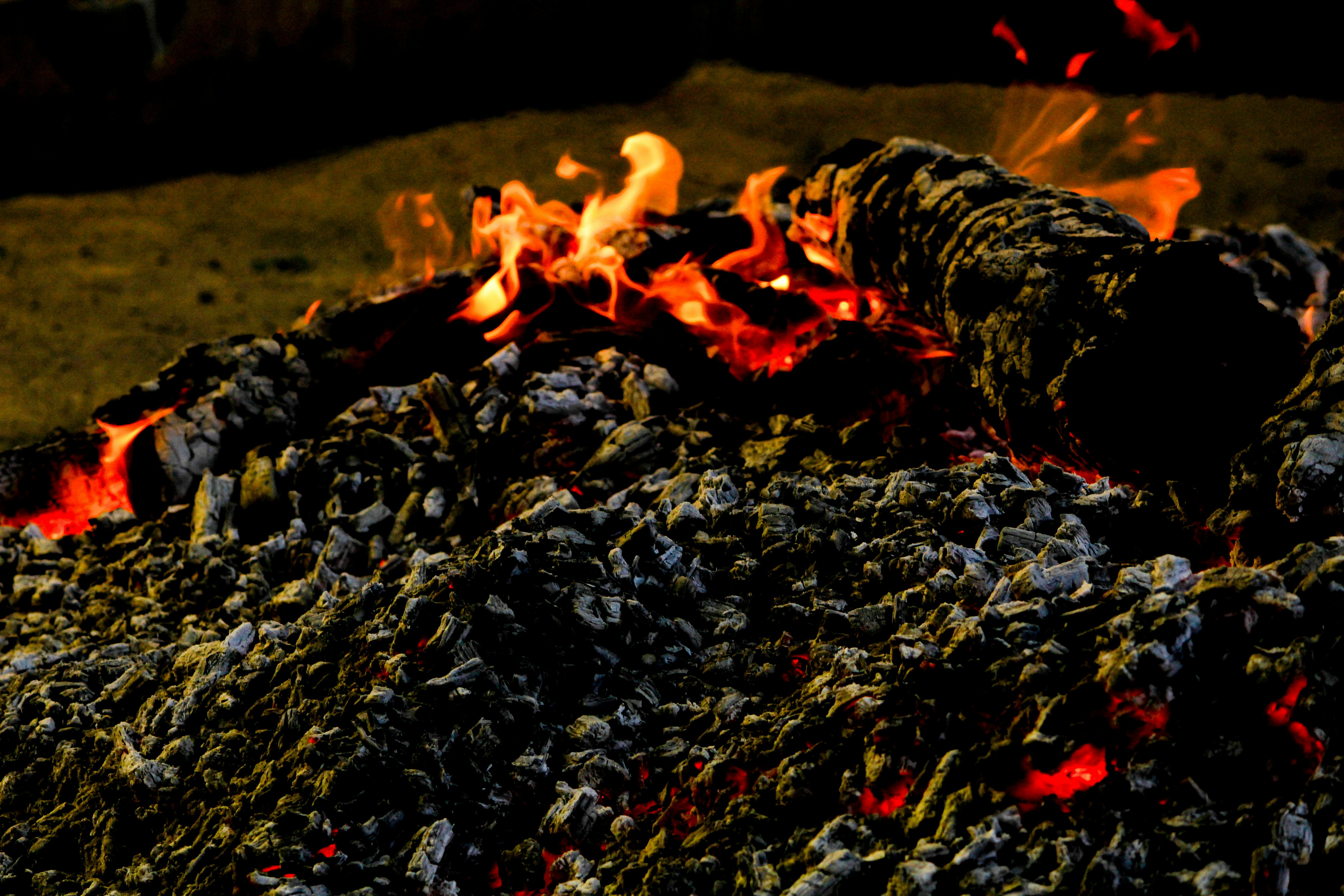 Embers under the Night Ash: A Closeup of Coals and Fire