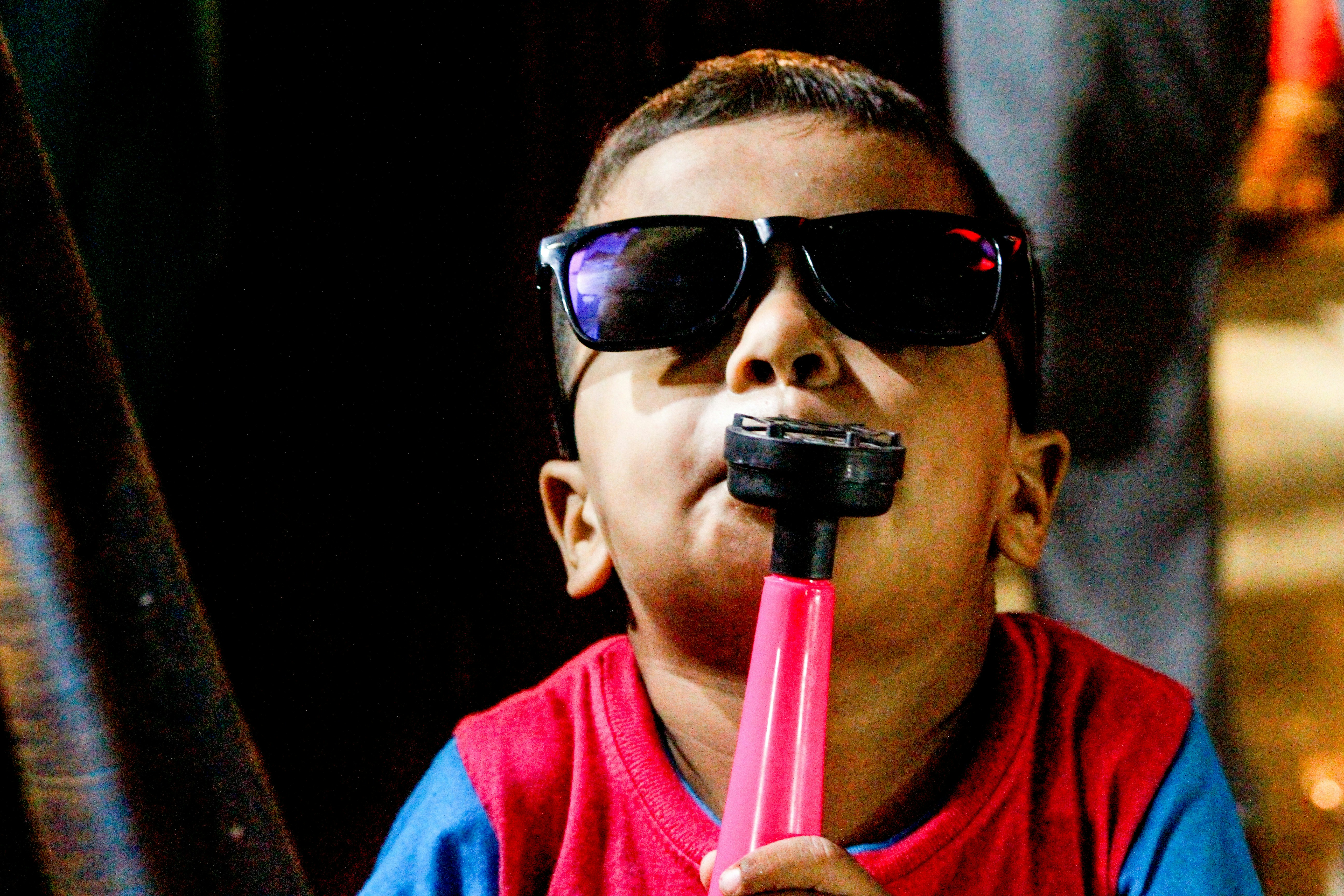 Bright-eyed Kid with Toy Microphone and Sunglasses