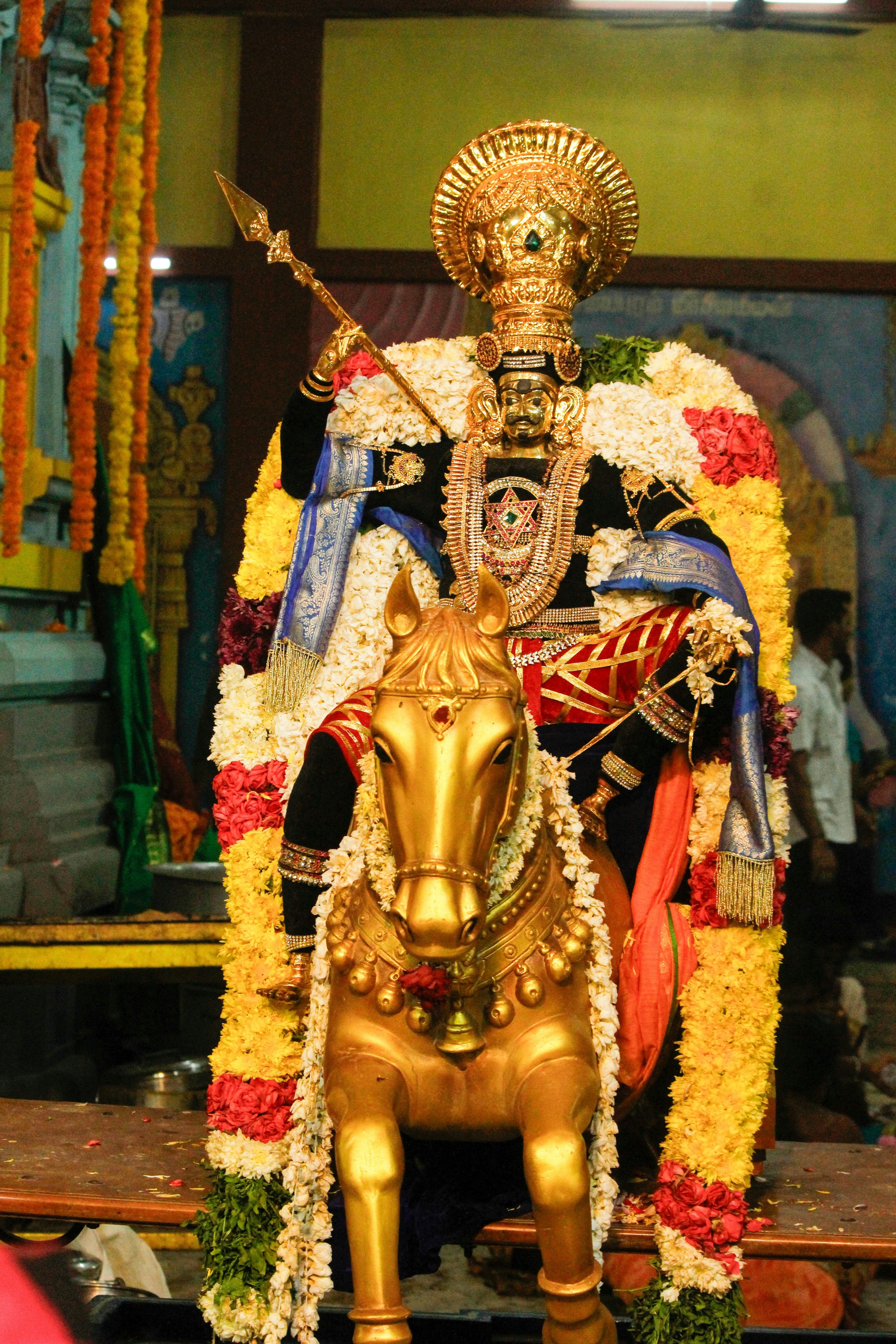 Divine Rider: A Regal Deity Enshrined in Ornate Ornamentation