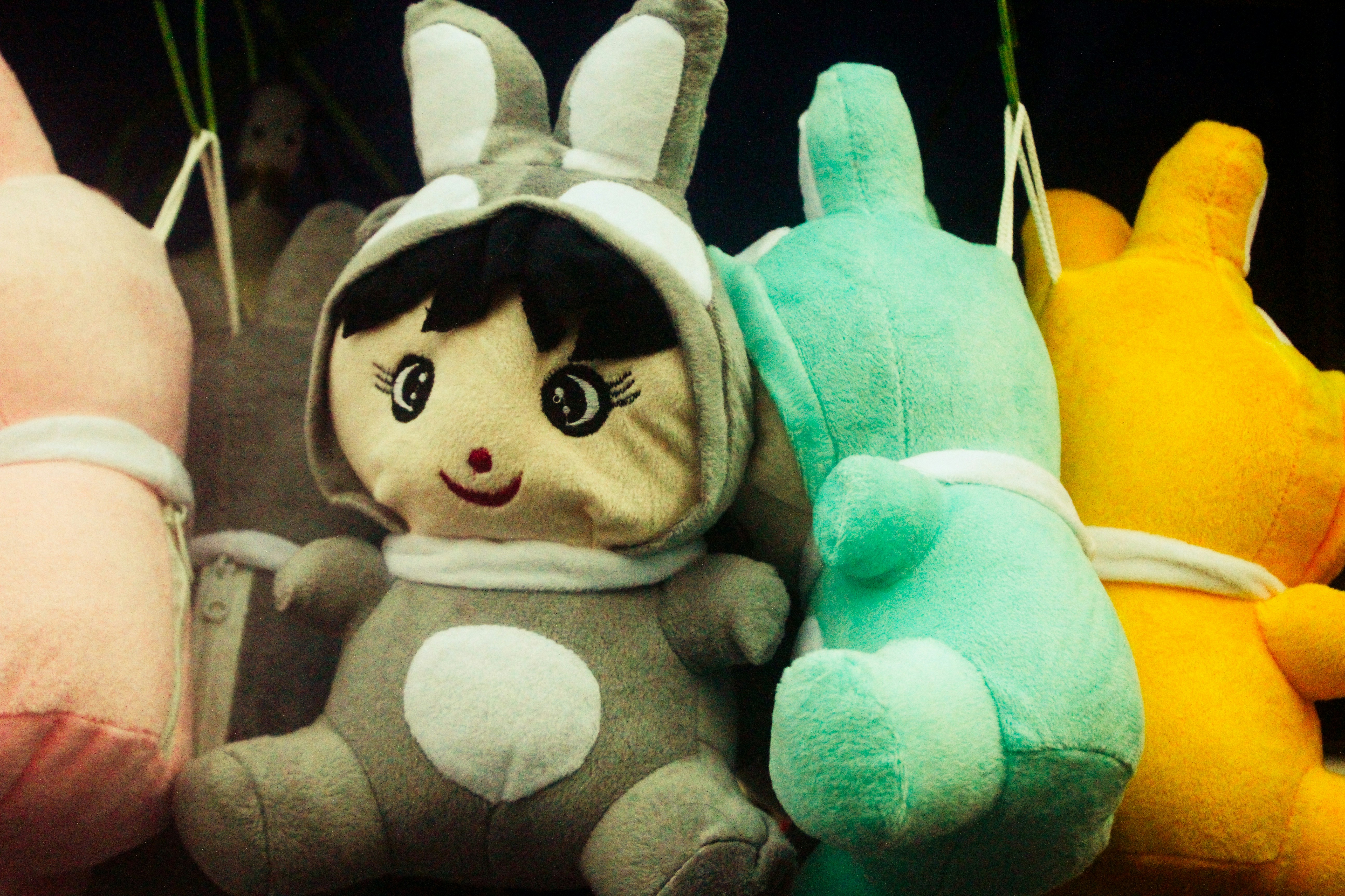 Grinning Plush Moonlight: A Row of Cute Friends in Soft Pastels