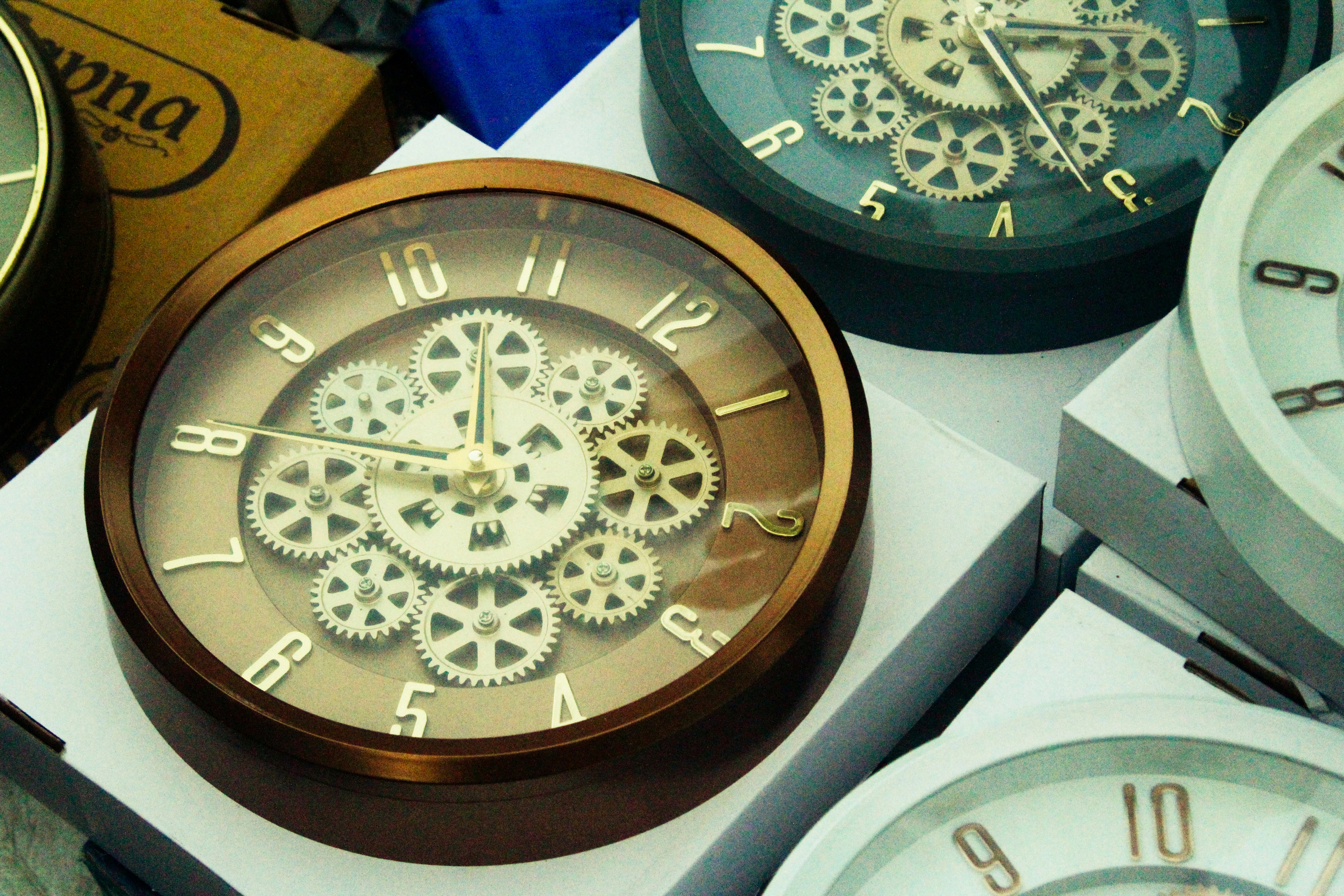 Gears of Time: A Brown-Rimmed Clock Among Stacked Dials