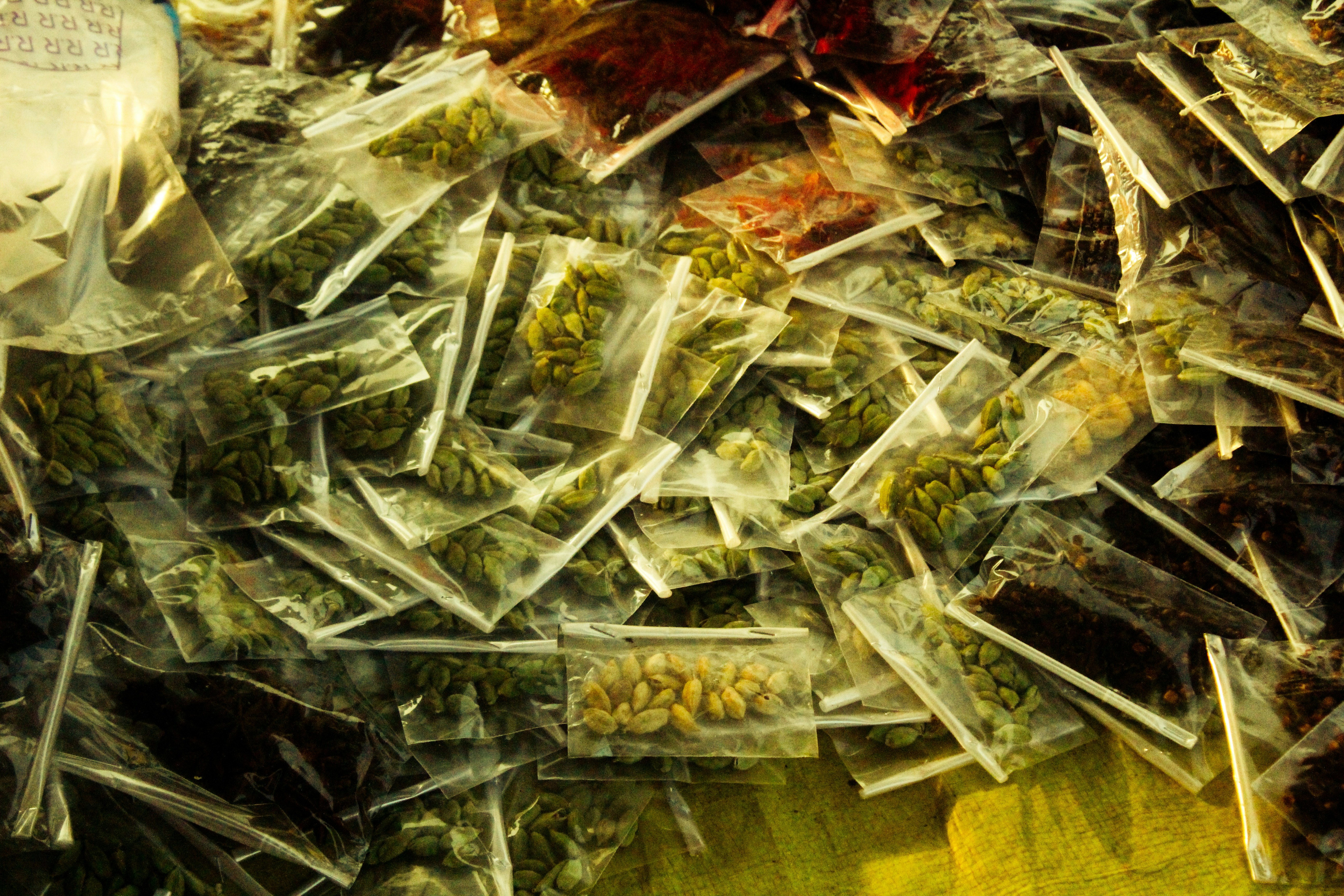Miles of Sealed Bursts: a sea of seed packets in a sunlit market stall