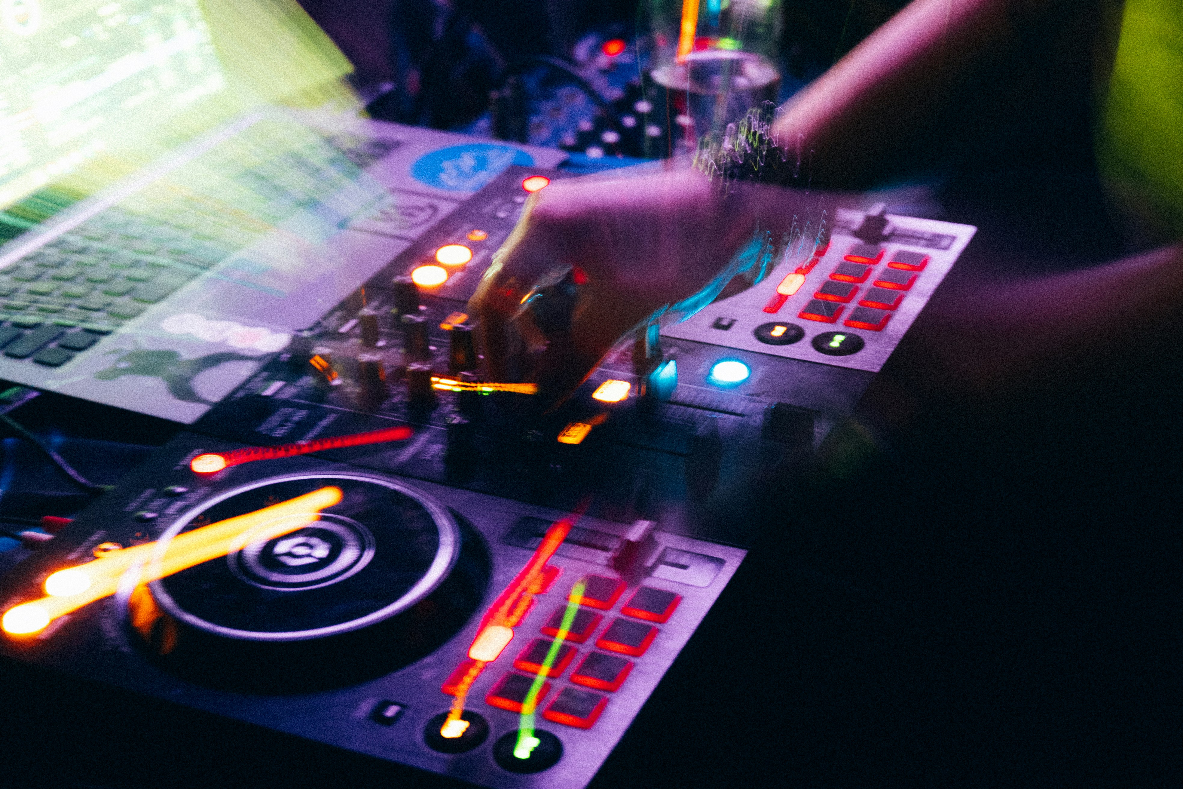 Neon Pulse at the Deck: A DJ's Hands in Motion