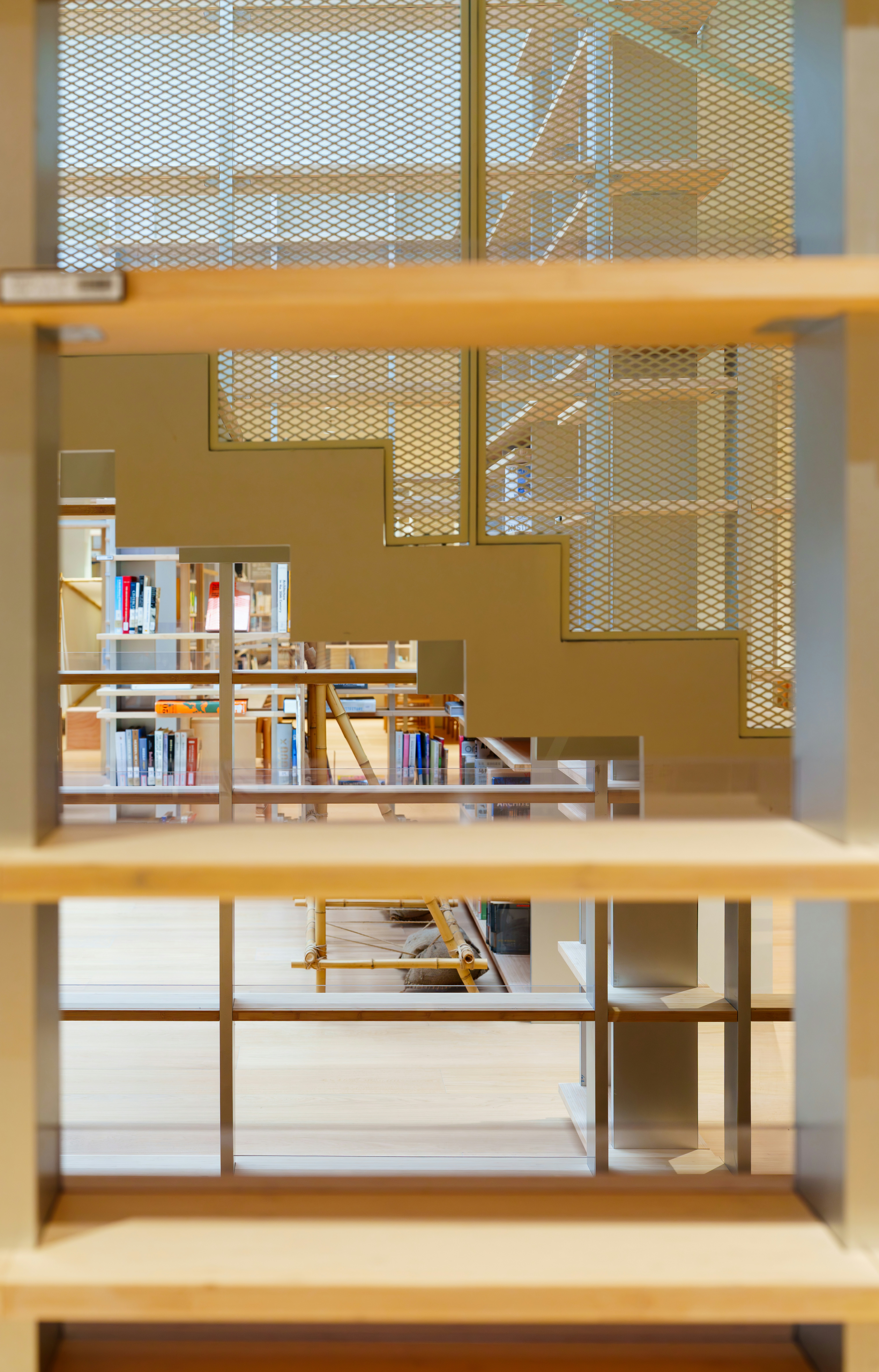 Geometric Staircase Through a Library Screen