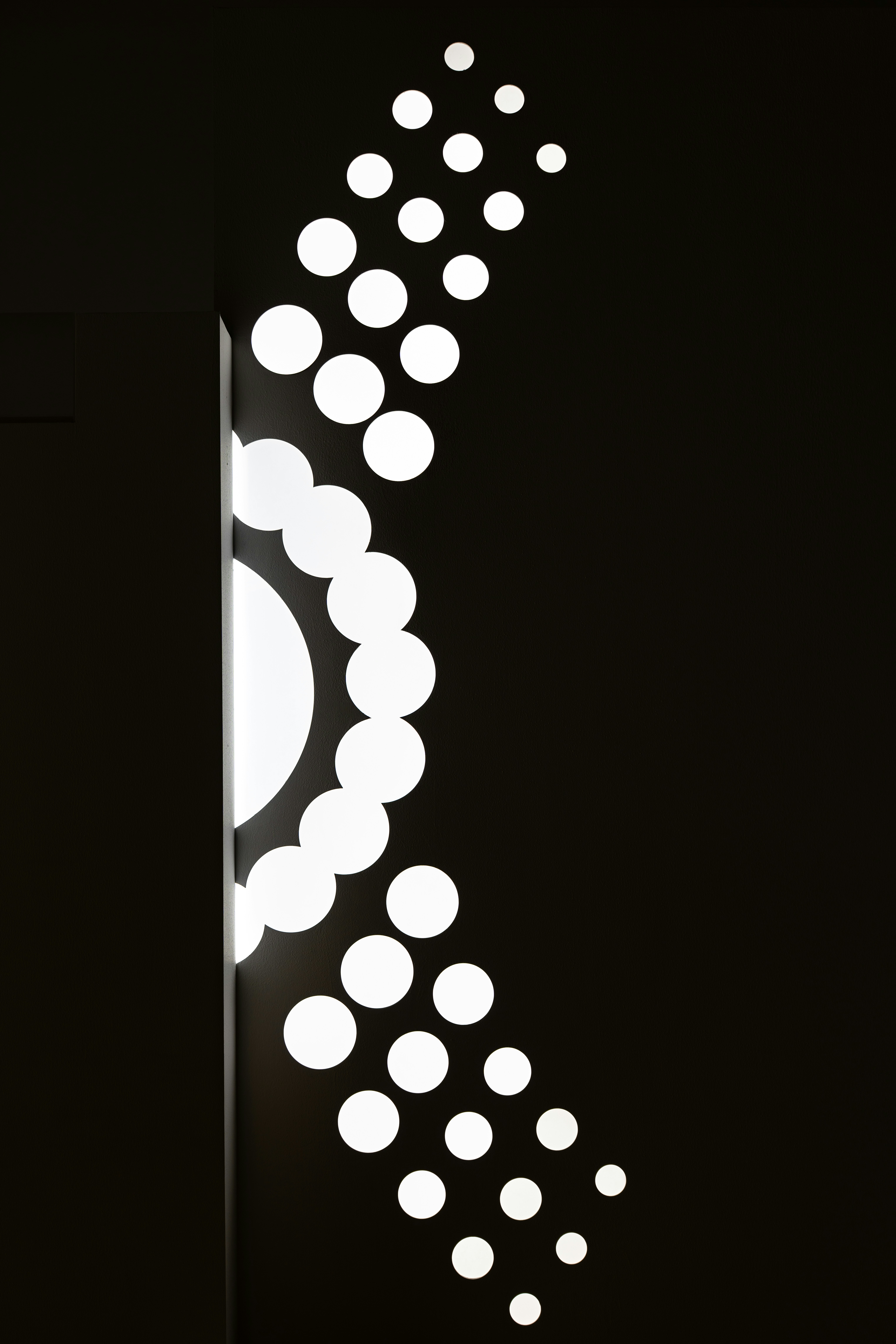 Architectural Light Rings on a Dark Wall