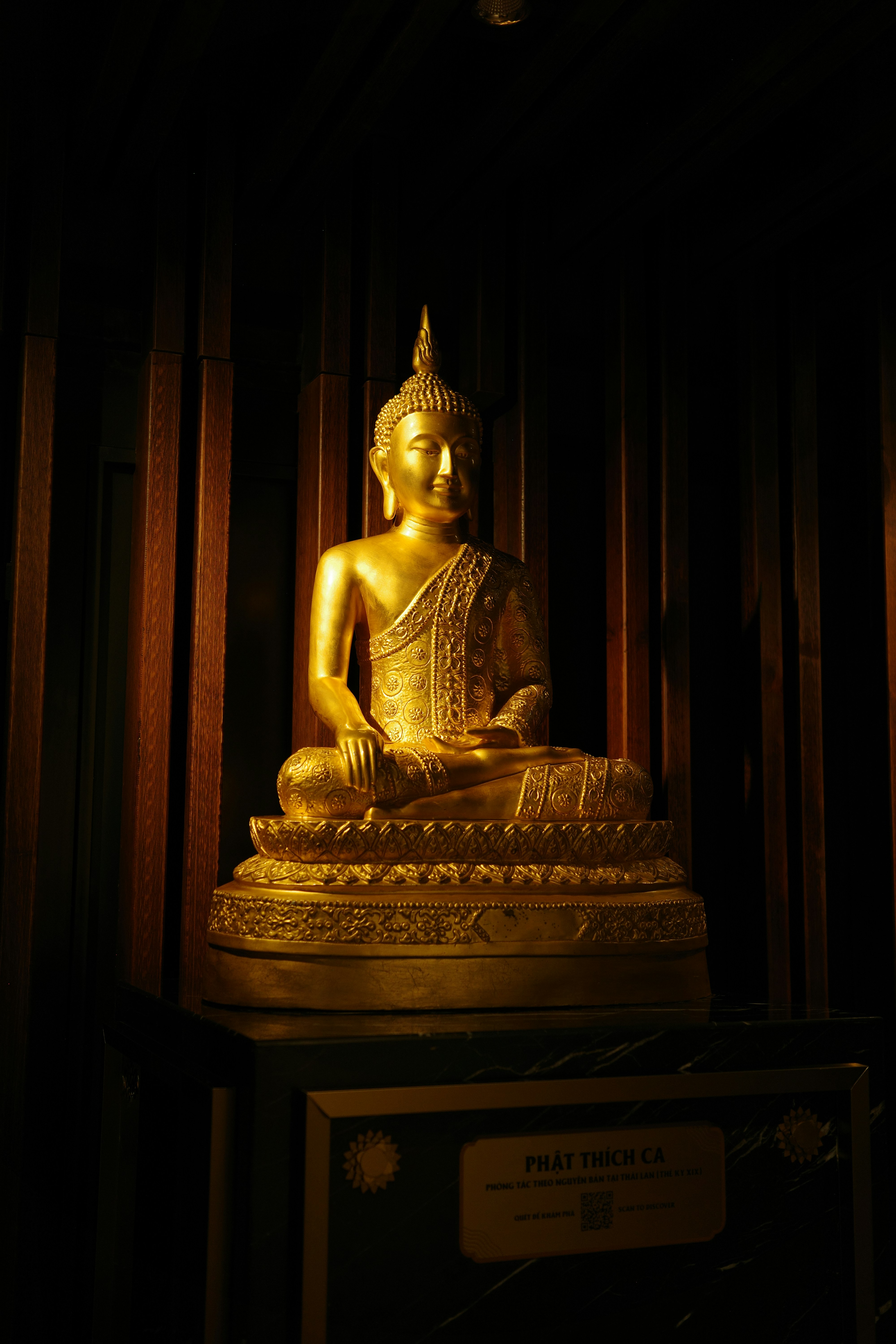 Golden Buddha Beneath Dim Light: A Quiet Shrine Moment