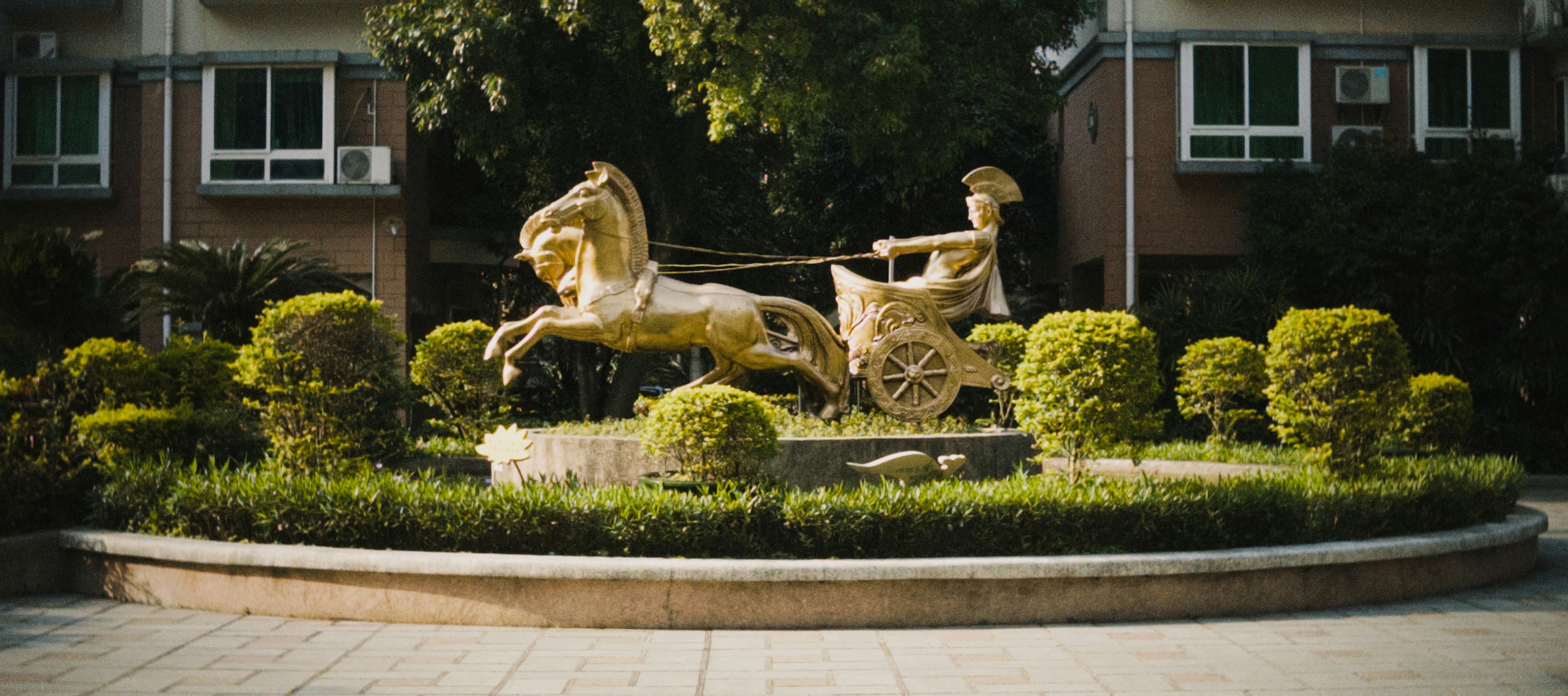 Golden Carriage Delicately Framed in a Circular Garden
