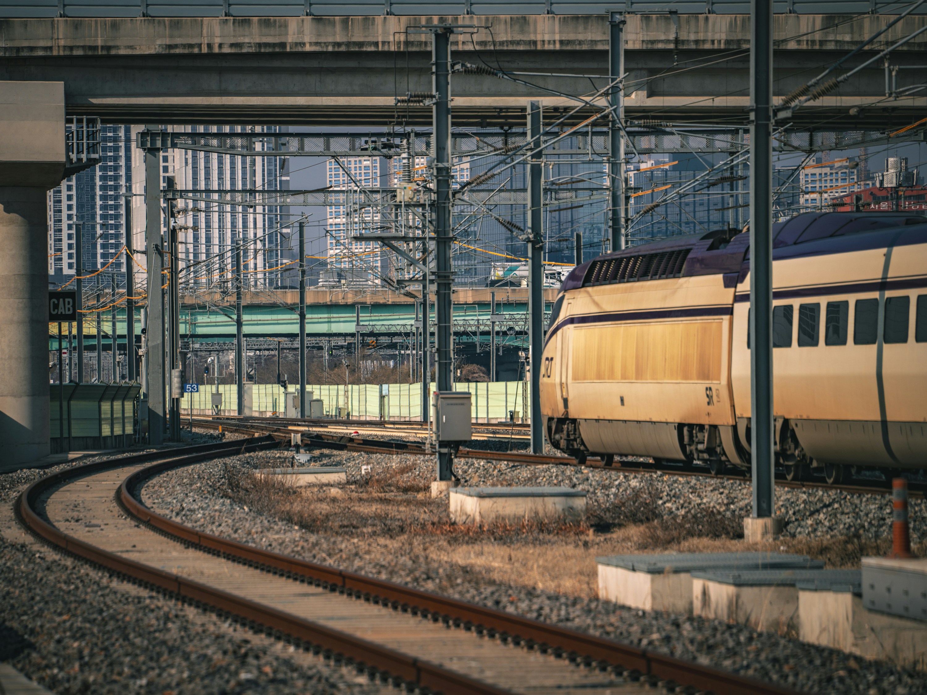 Commuter Train Rounds the Curved Rails Under a Silent City