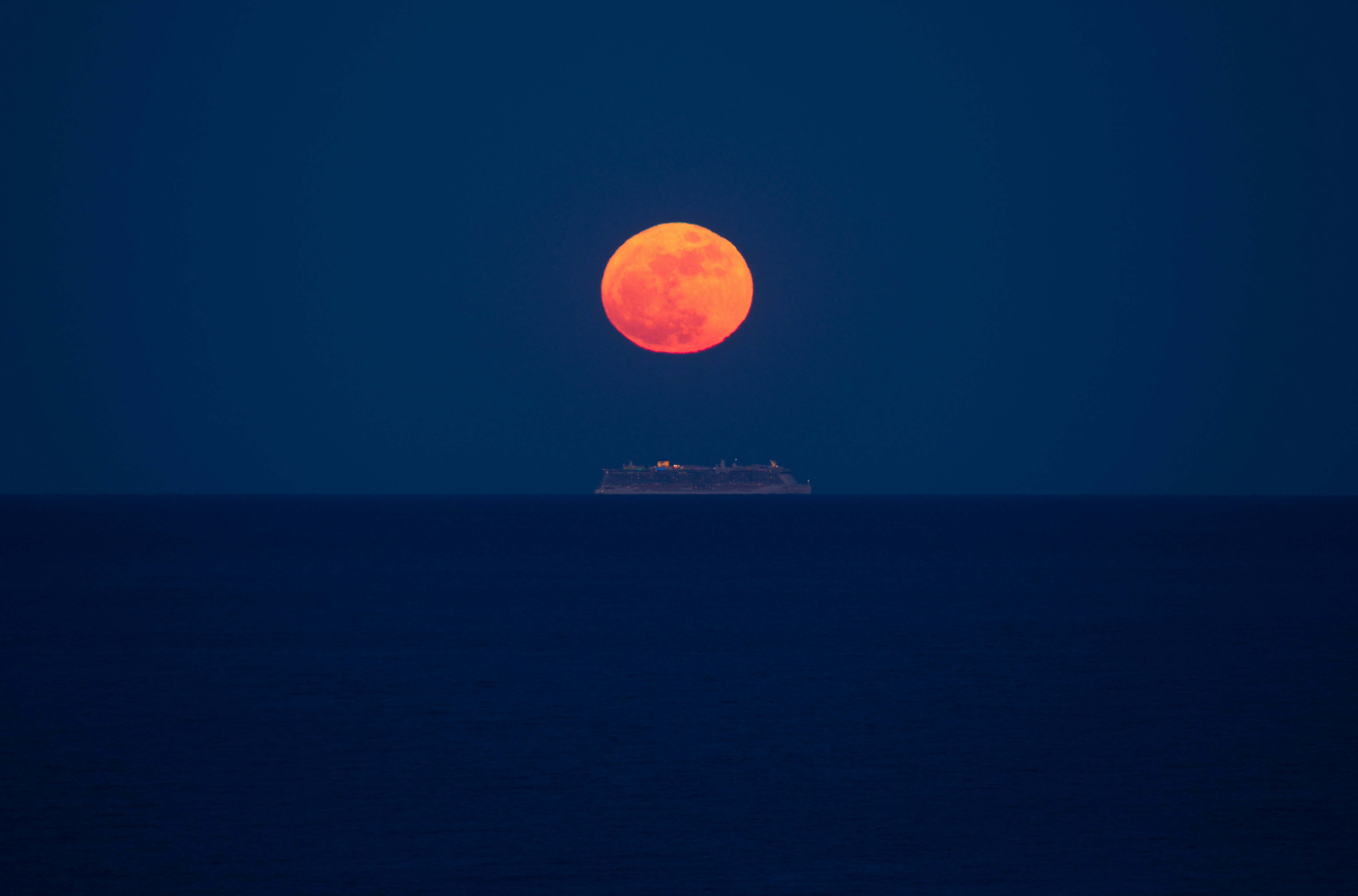 Moonrise Ferry: A Red Moon Over Silent Seas
