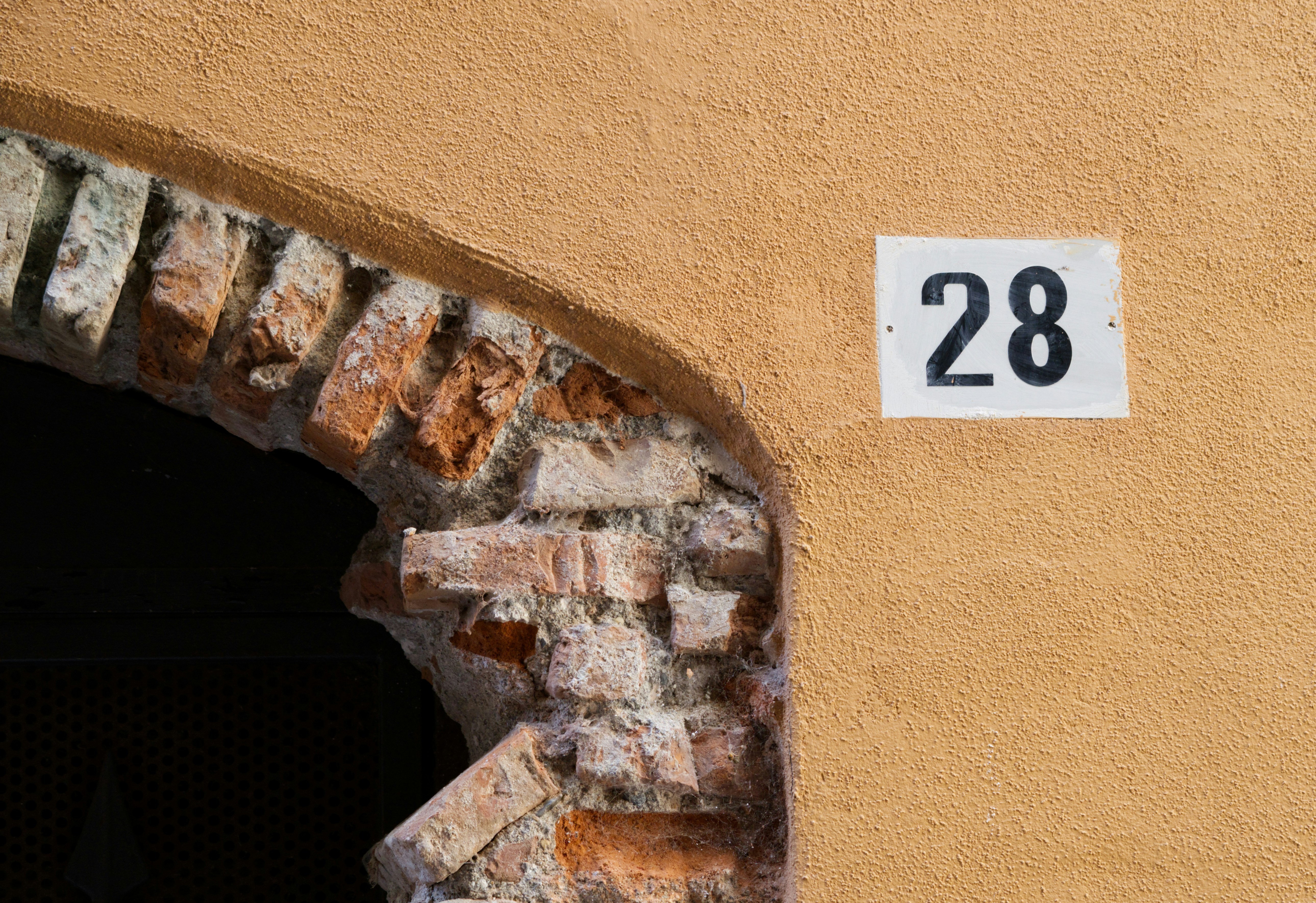 Terracotta Archway Framed by Weathered Brick