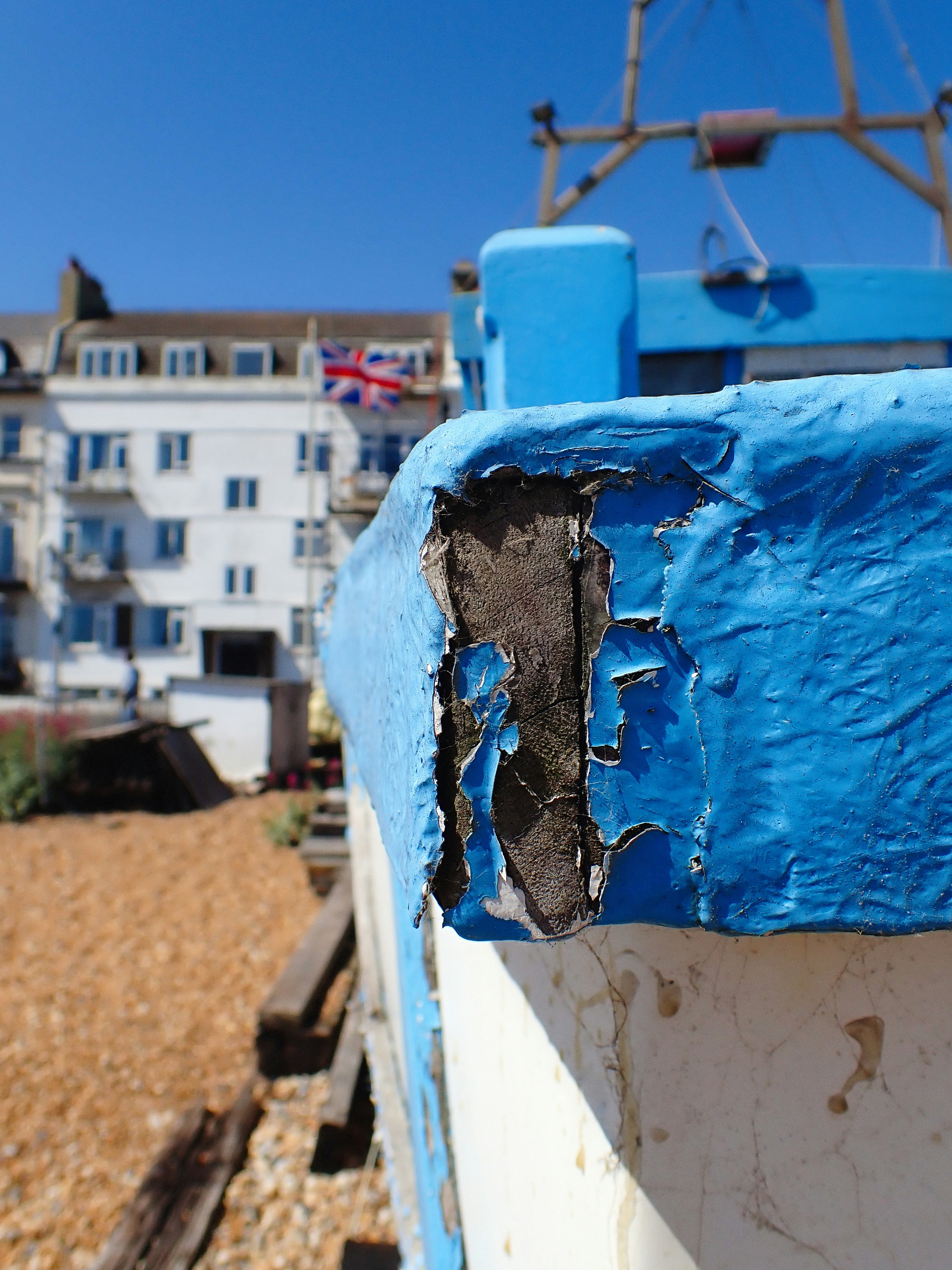 Cracked Cerulean Barrier: Coastal Blue Wall in Focus
