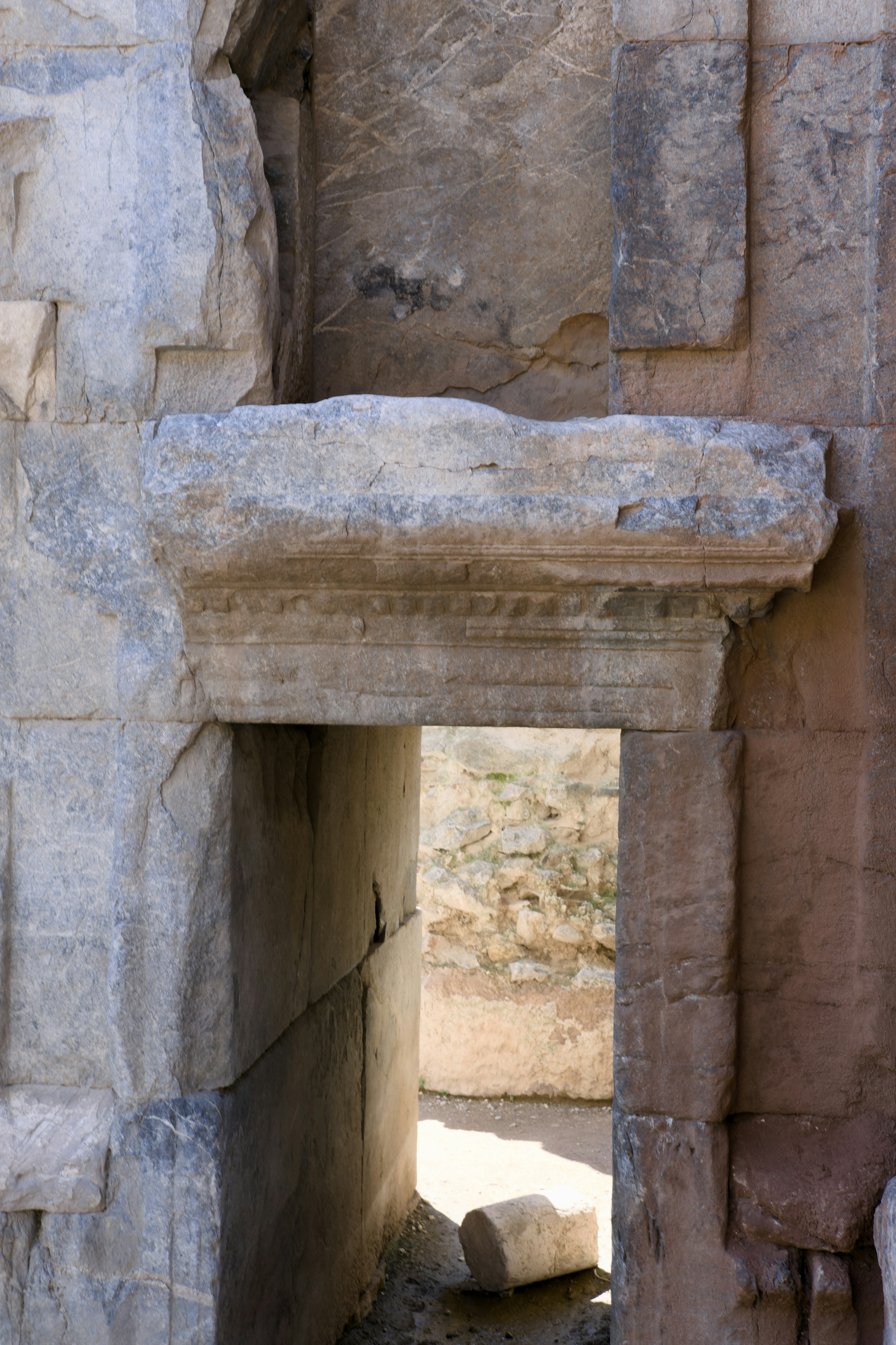 Stone doorway through the ruin: light at the threshold