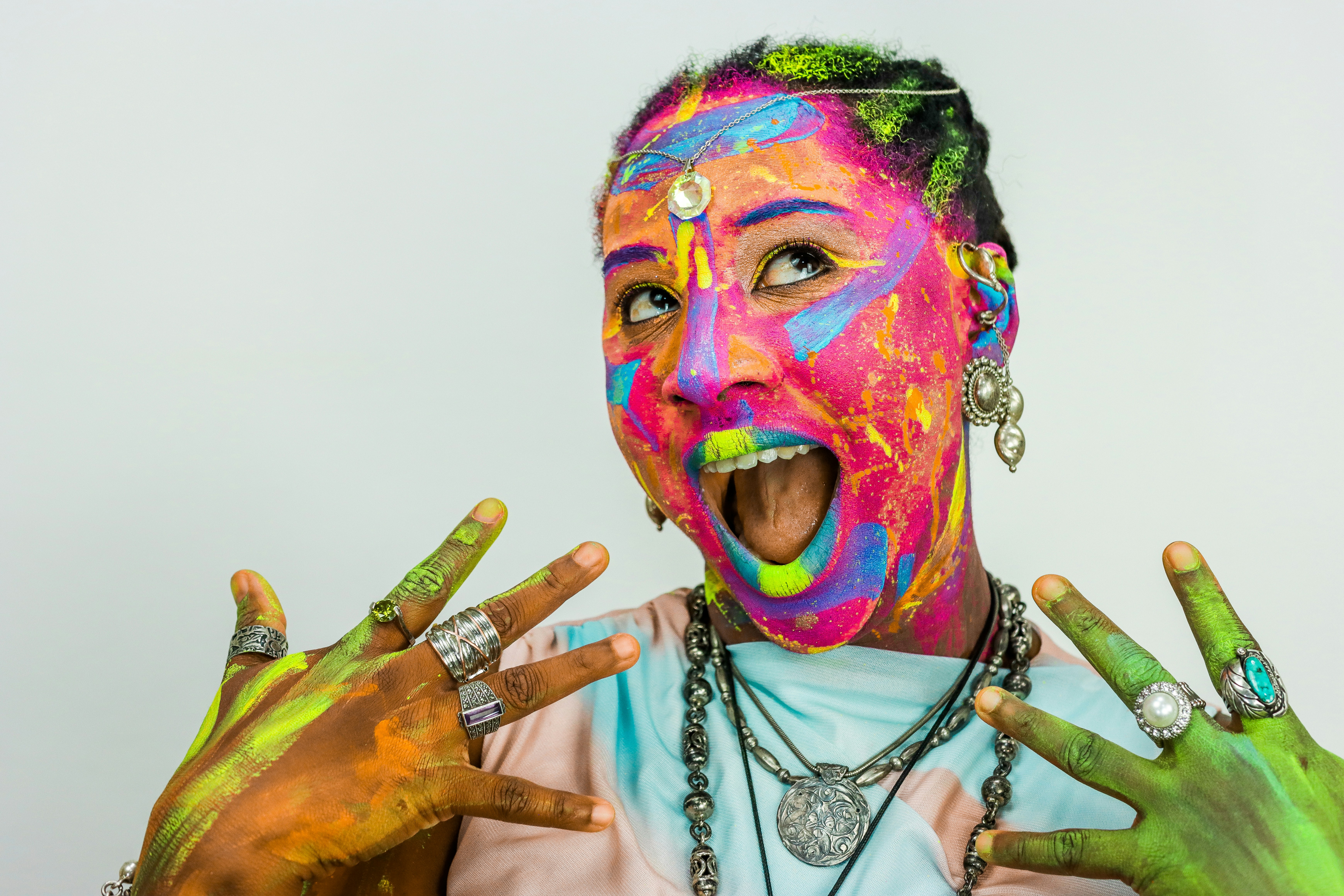 Face Painted Carnival: A Burst of Color Over Hands and Smile