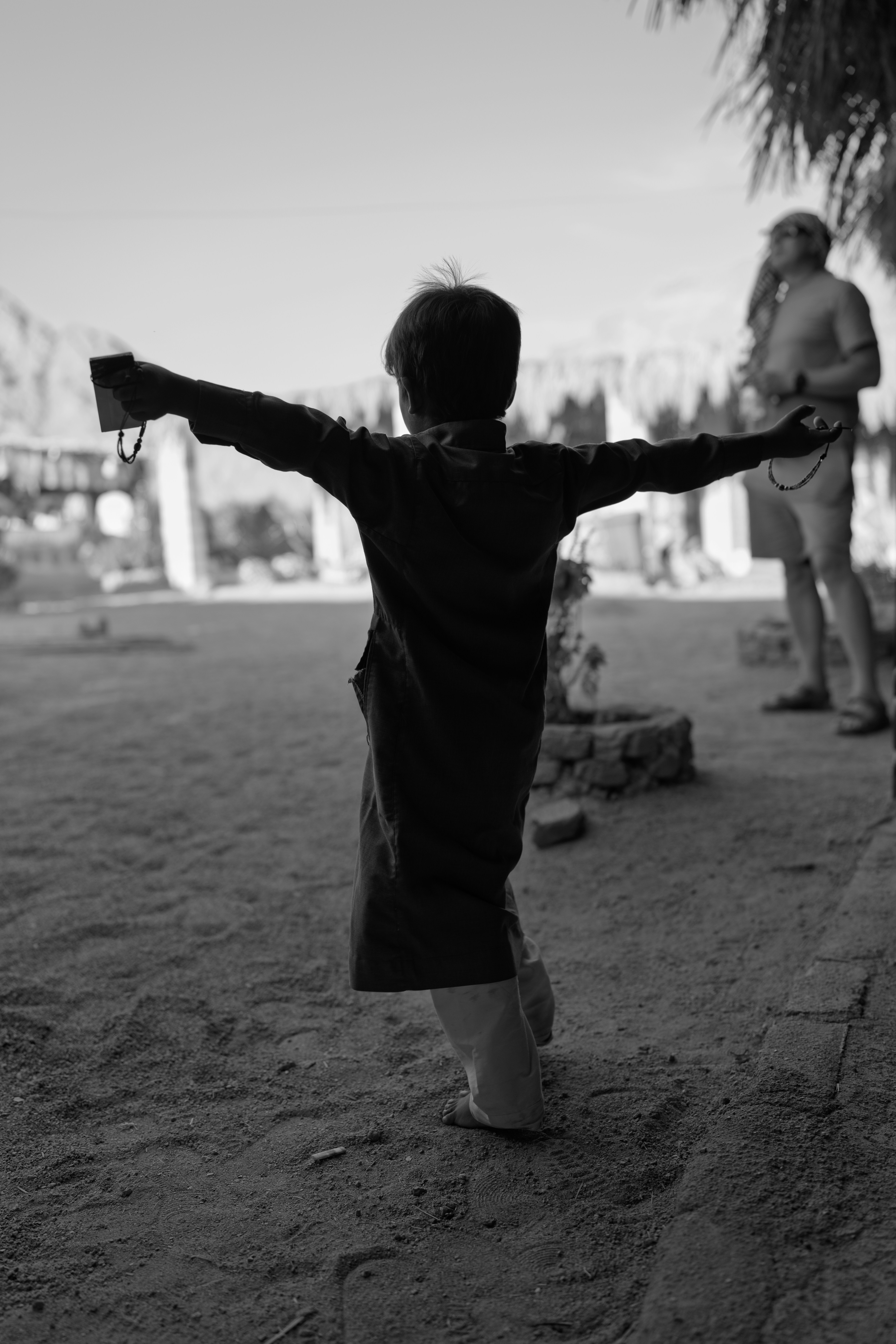 Arms Wide at Sunset: A Child Embraces the Moment