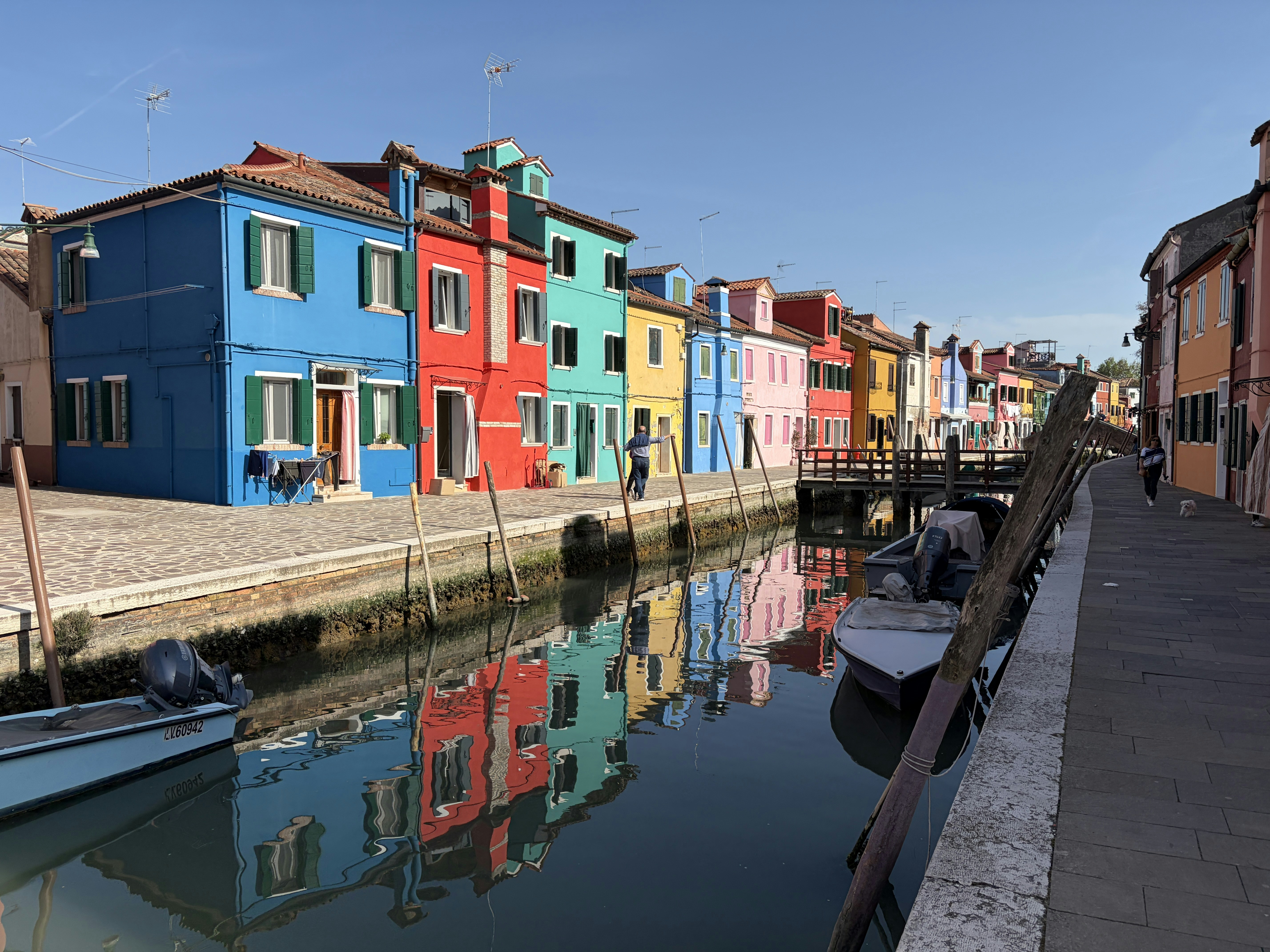 Ribboned Canal: A Row of Painted Townhouses Reflecting in Quiet Waters