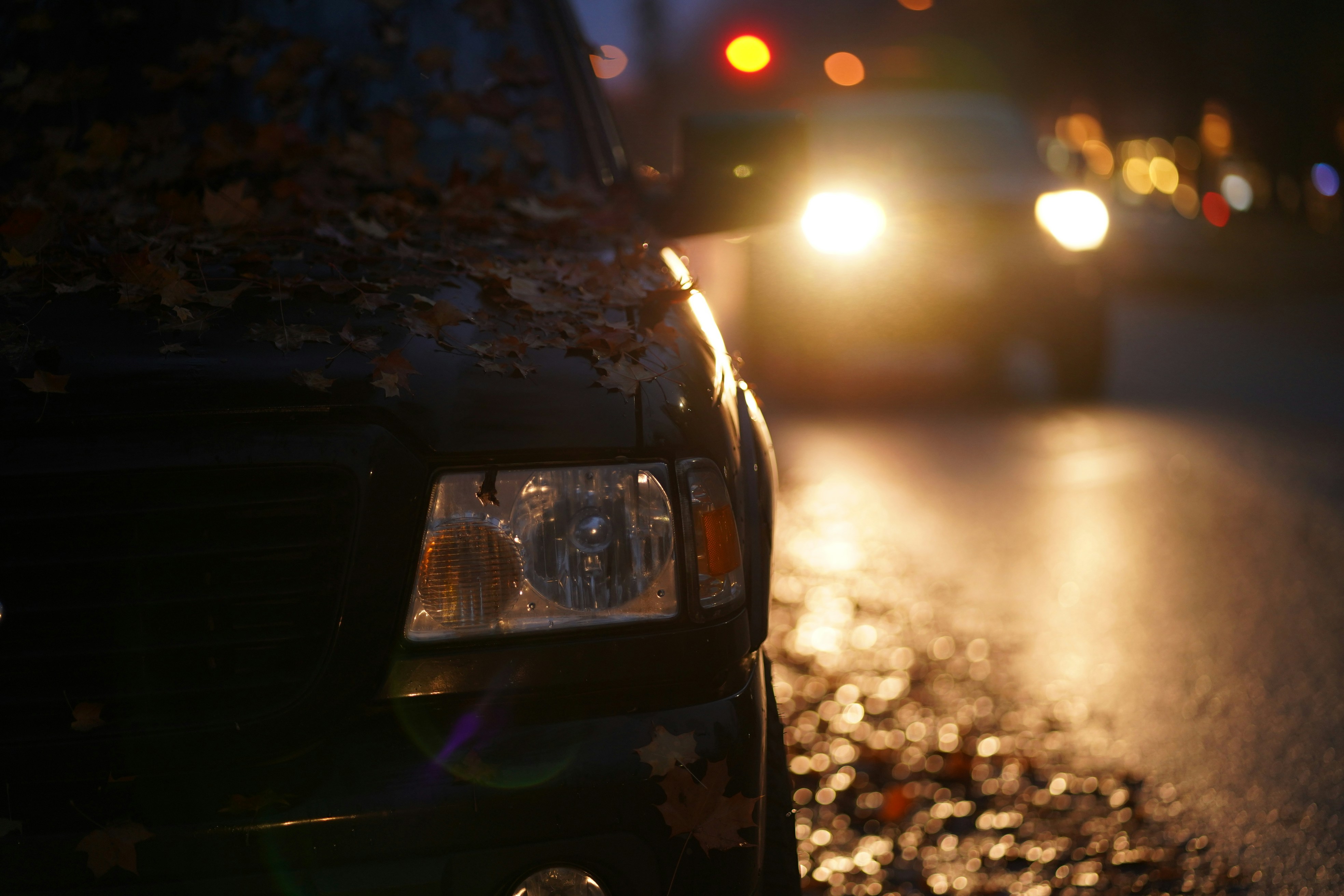 Headlight Glance on a Quiet Street at Dusk