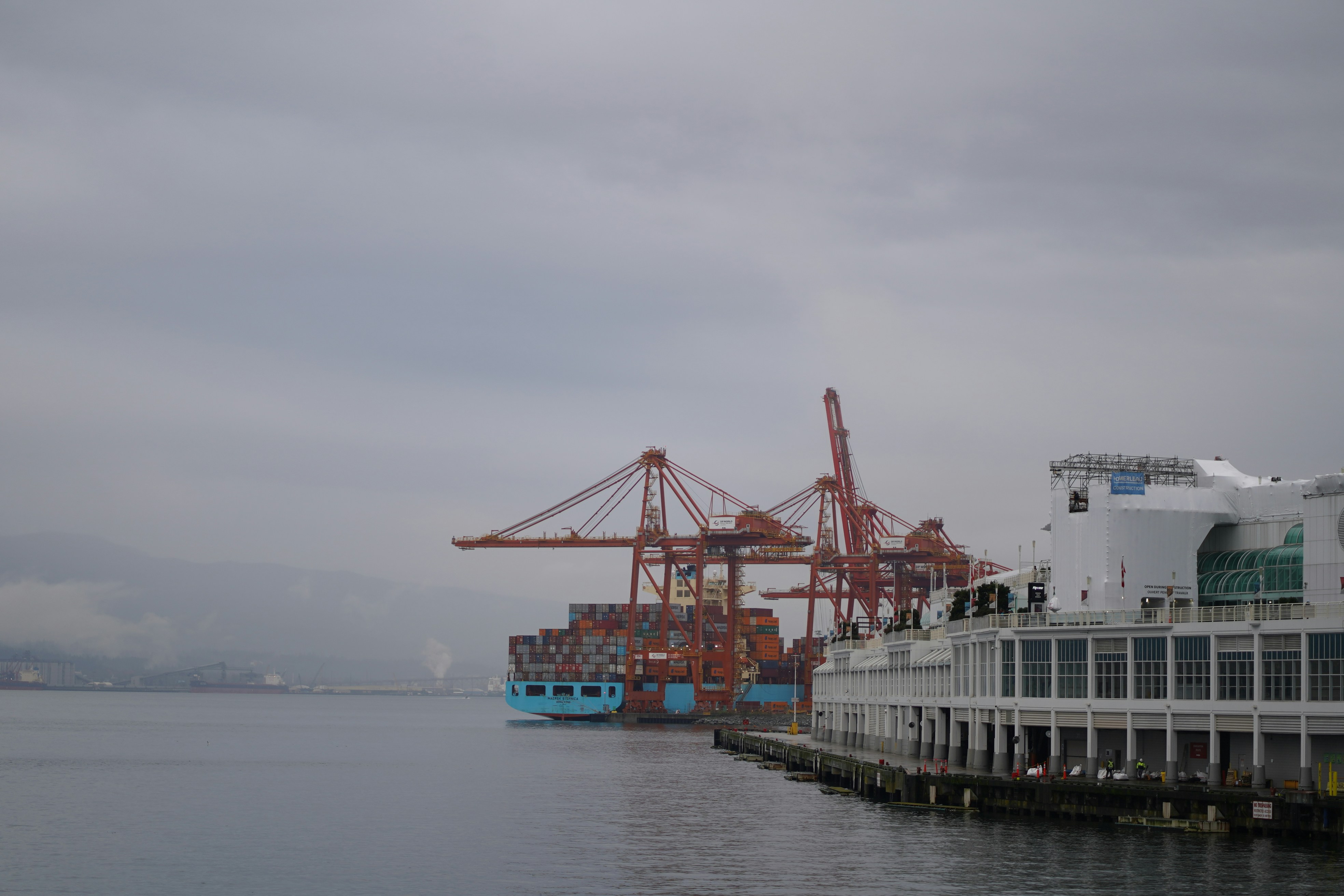 Harbor Giants: Cranes and Passenger Pier at Dusk