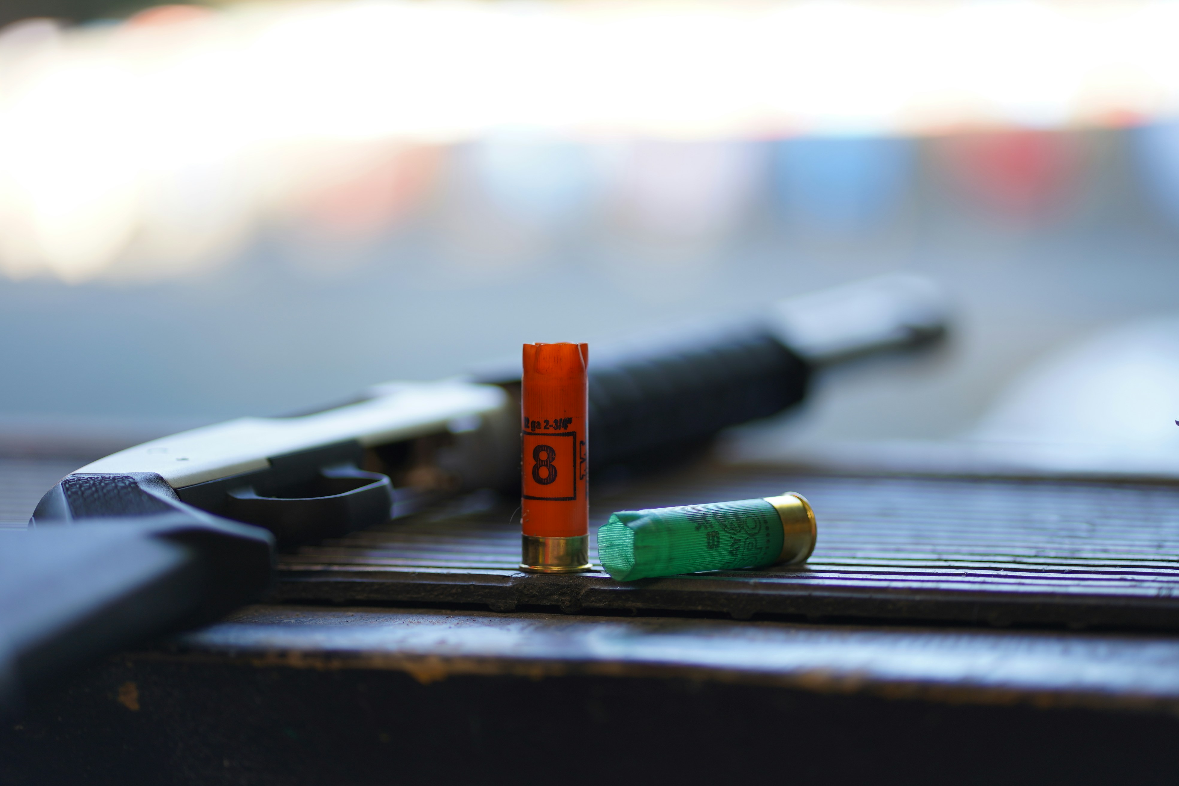 Charred Orange Cap and Green Capsule: A Quiet Still Life on a Wooden Surface