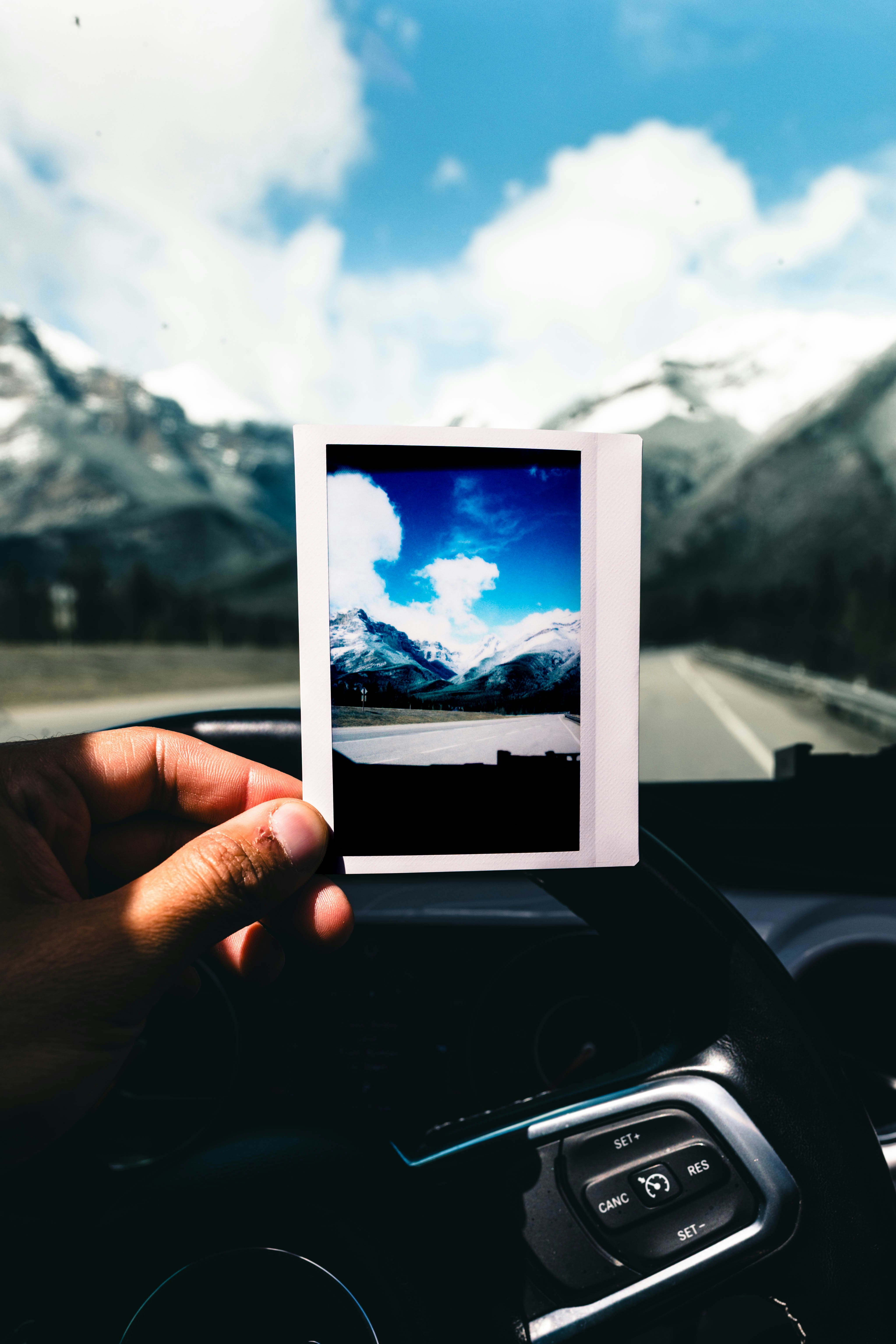 Mountains in a Photo within a Photo: A Traveler’s Polaroid Moment