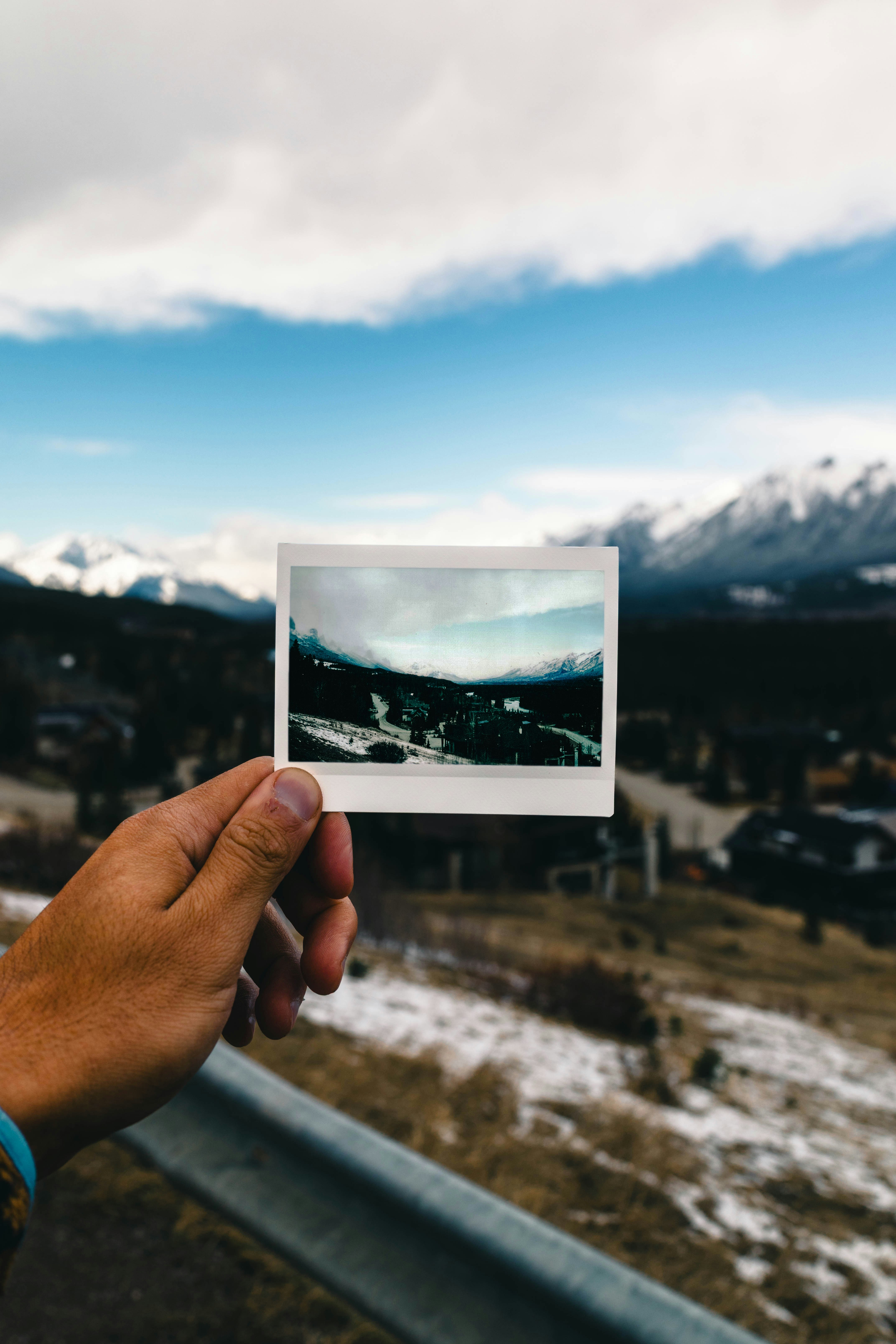 Polaroid Moment: Hand-Held Echoes of a Mountain View