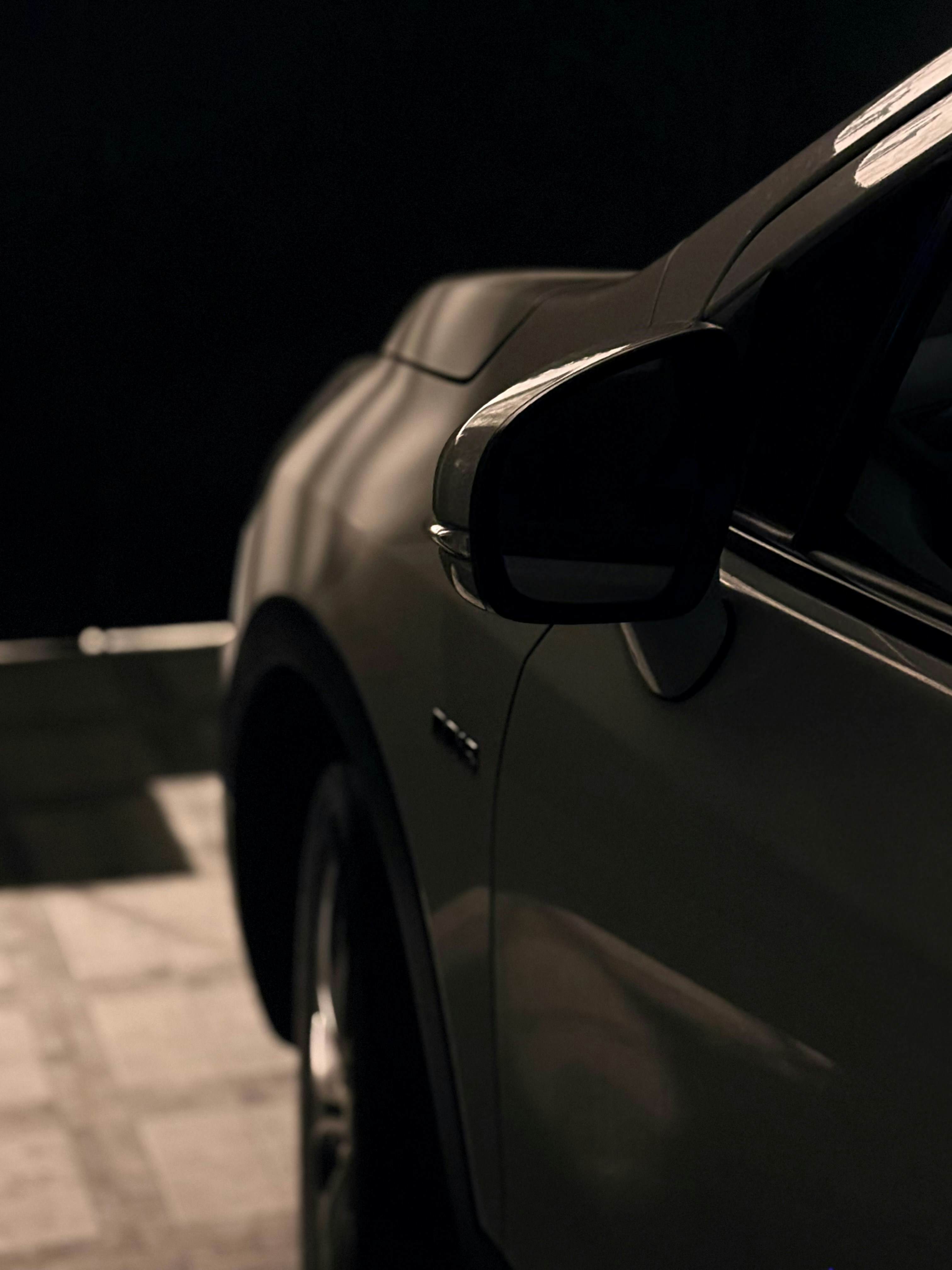 Midnight Gleam: A Side Profile of a Car in Shadowed Studio Light