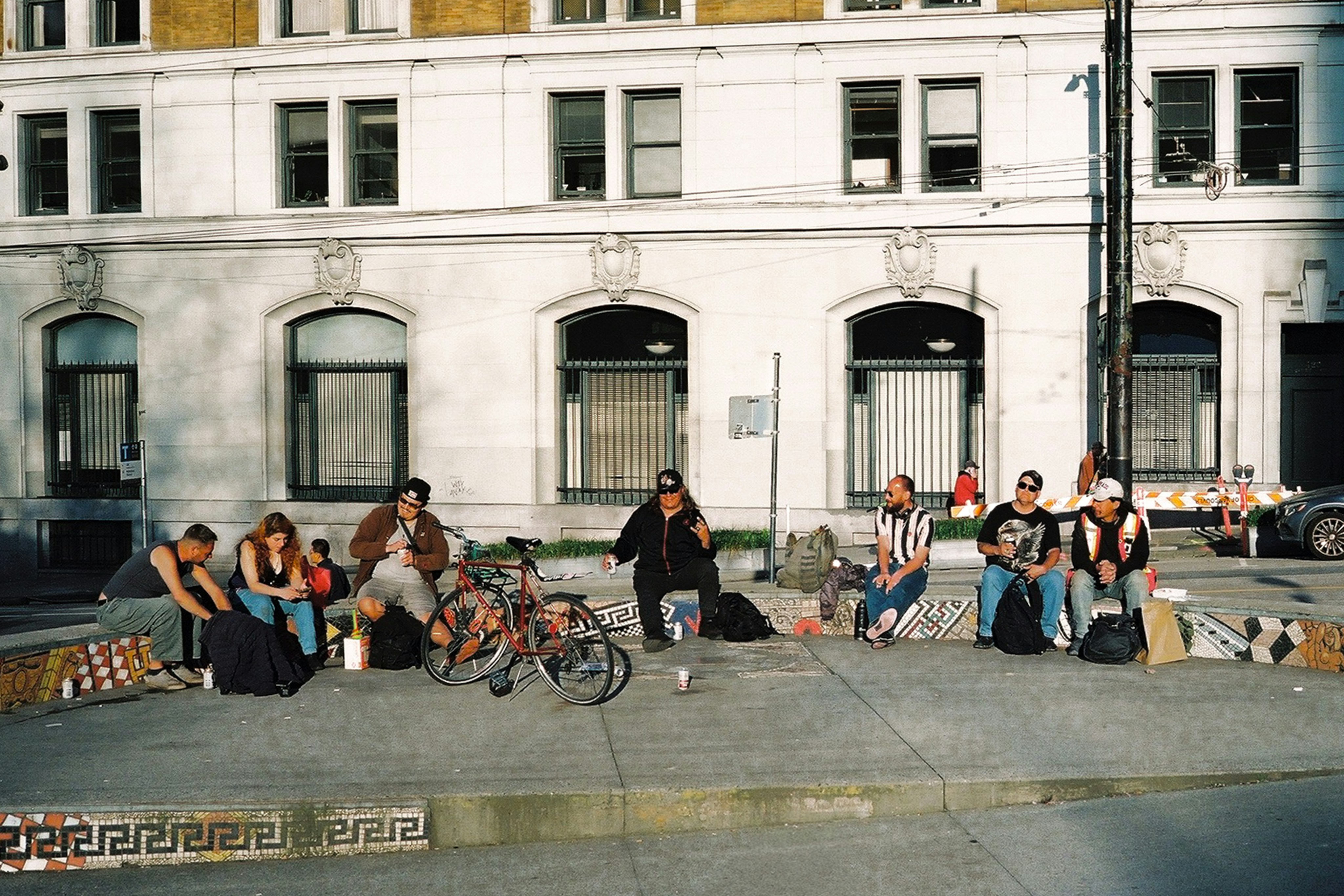 Street Collective: Faces and Moments Along a Sunlit European Facade