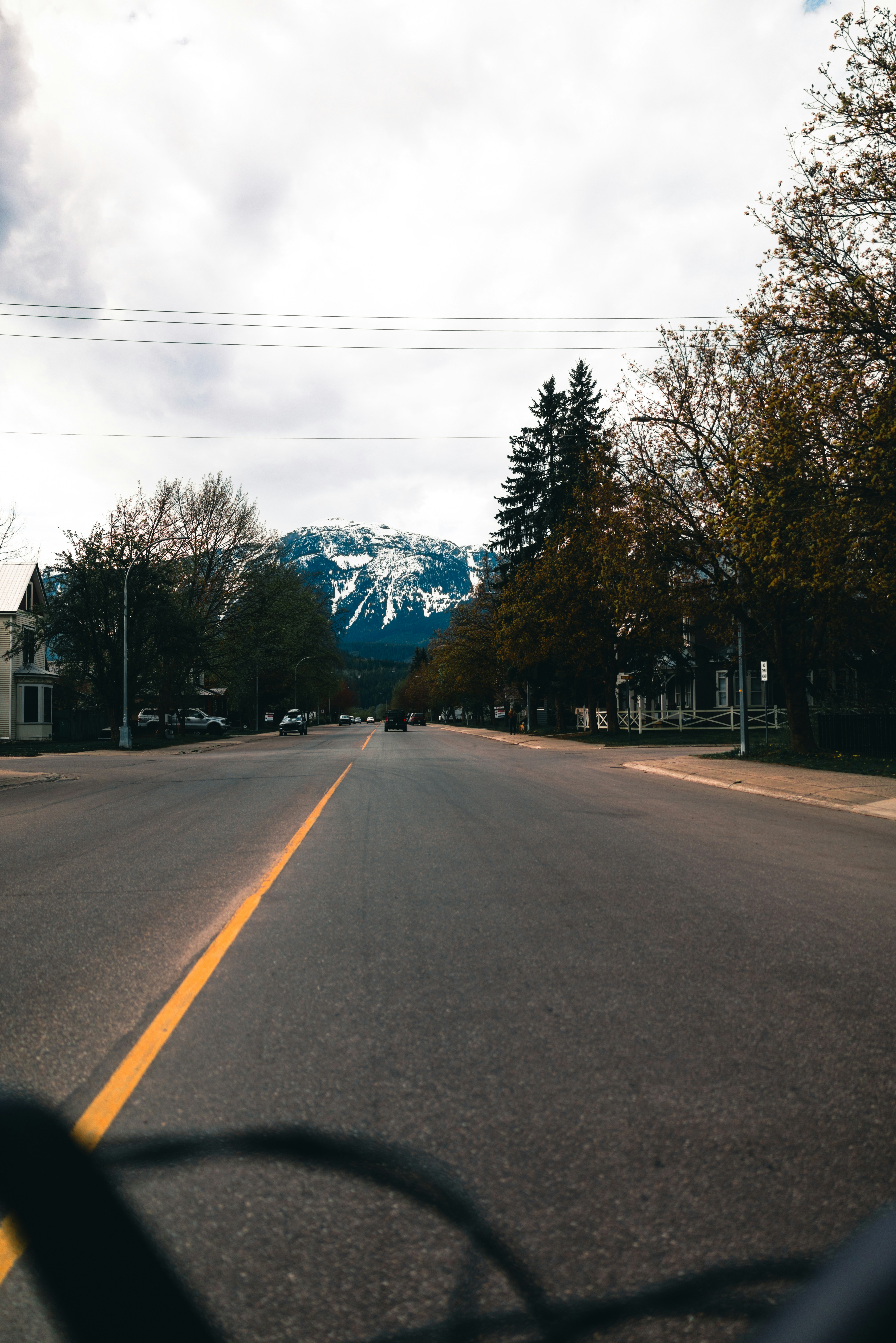 Snow-capped mountain peeking over a quiet town street