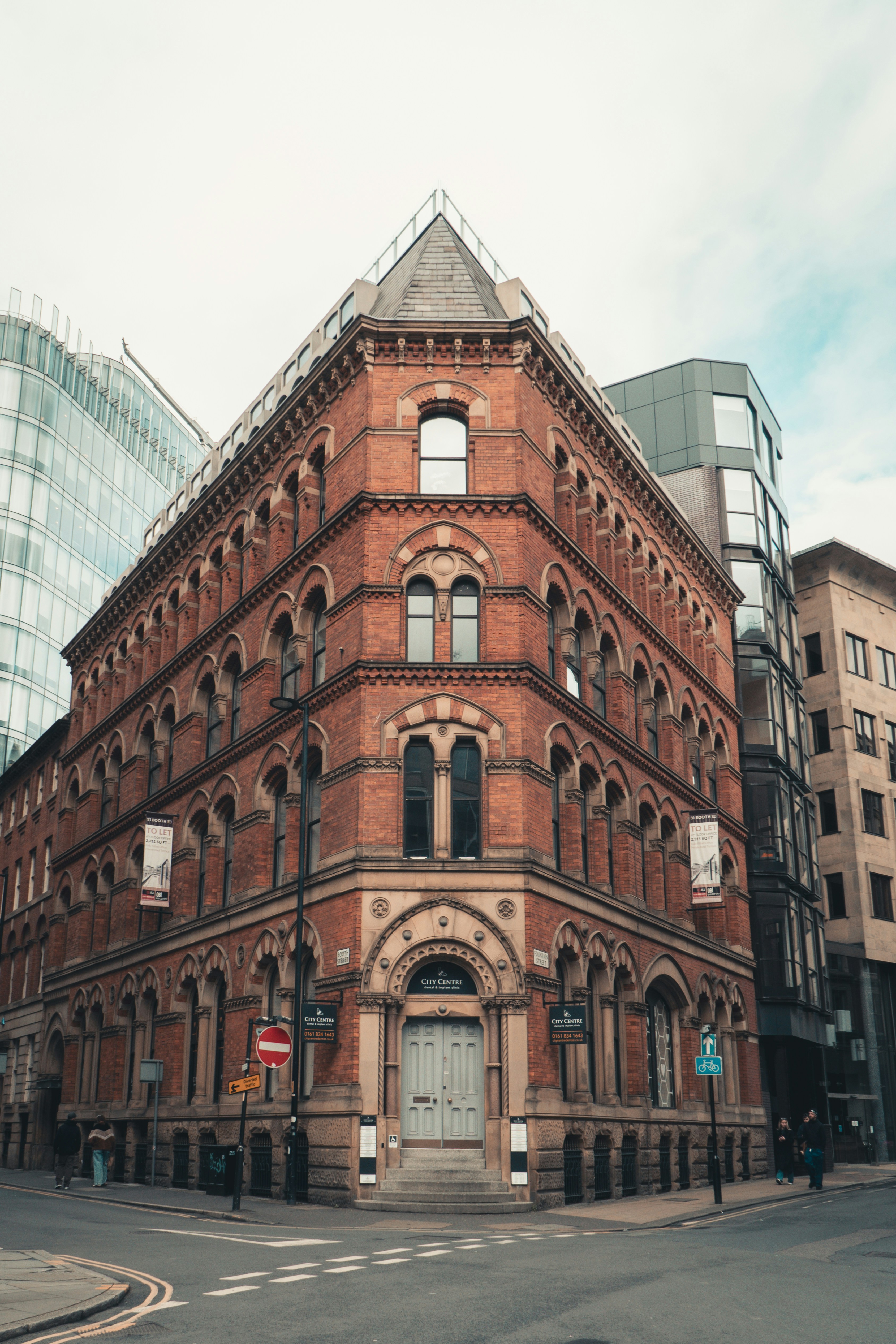 Heritage Brick Cornerstone: A Historic Facade Rising Over Modern Streets