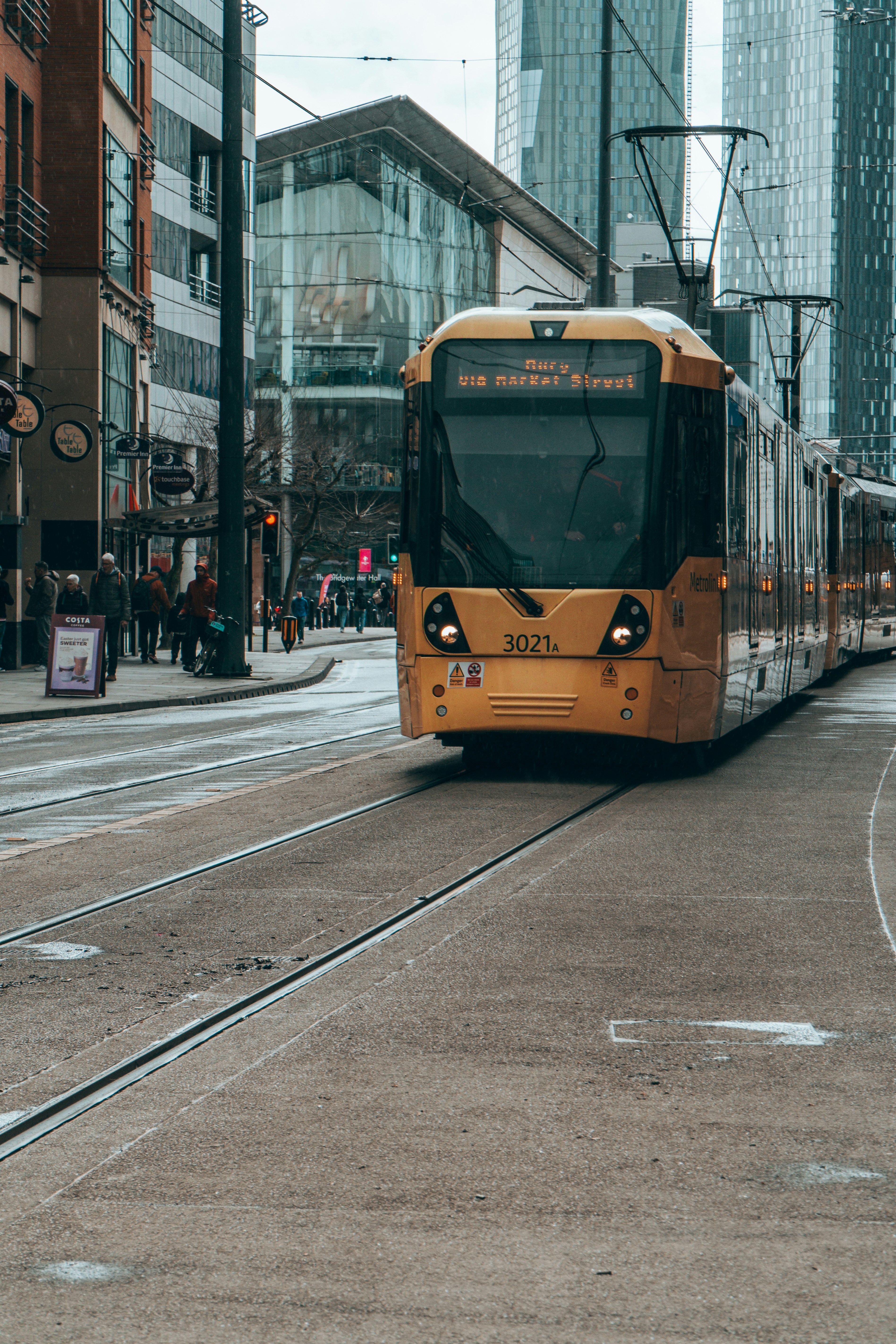 Urban Dawn: The Yellow Tram Carving Through a Modern Skyline