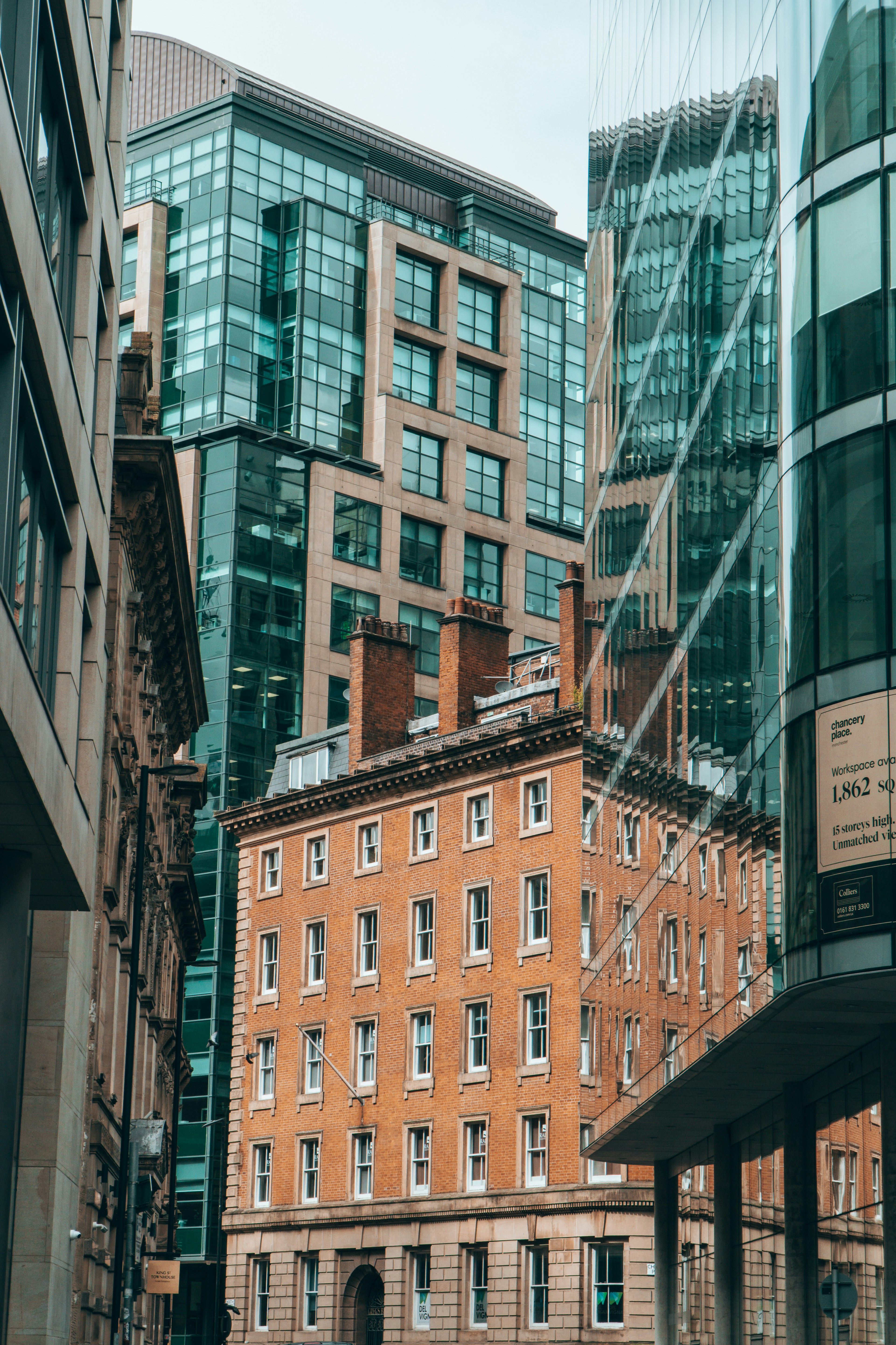 City Facades Converge: Glass, Brick, and Skyward Geometry