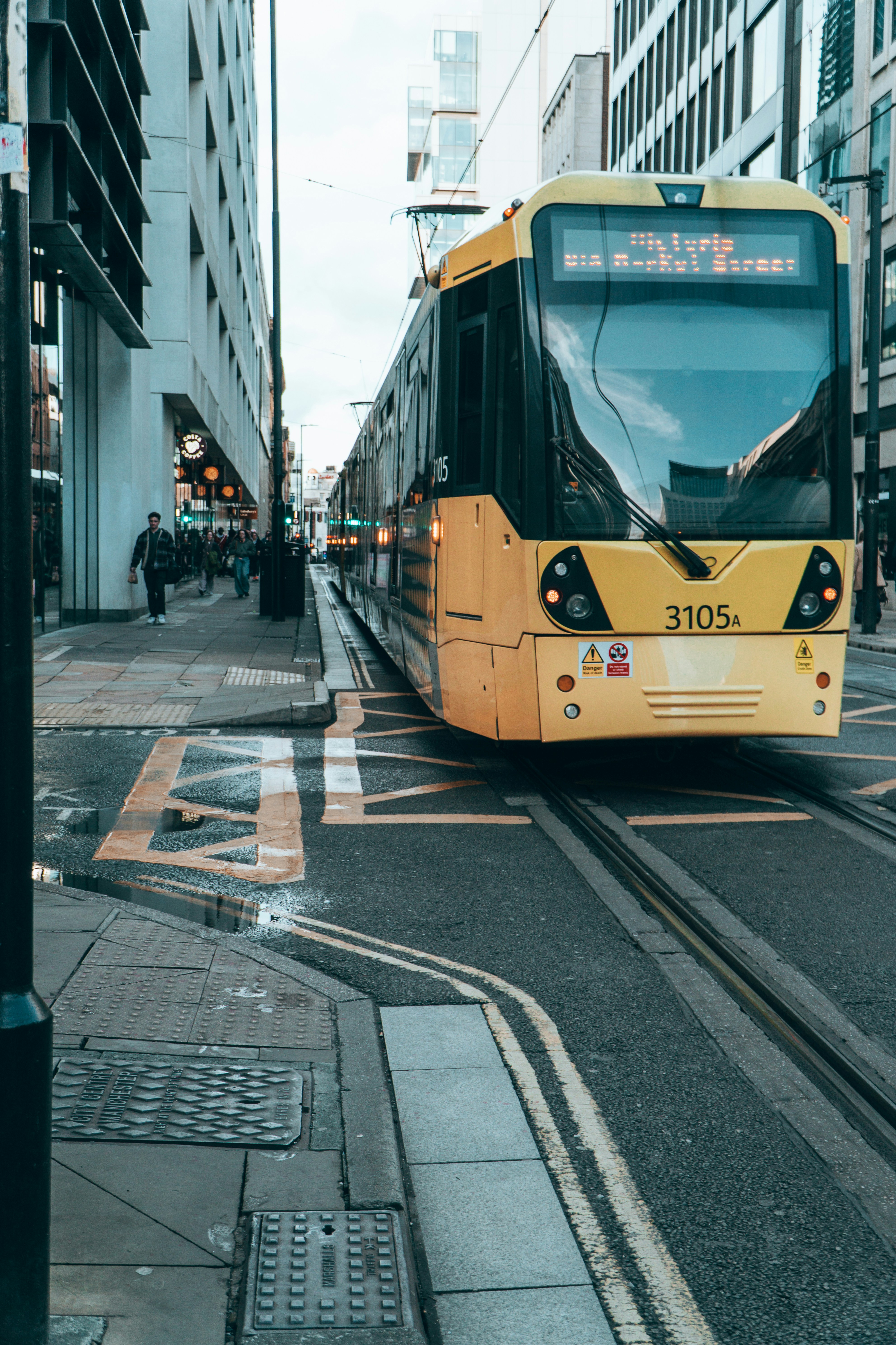 Golden Commuter: A City Tram Rounds the Corner