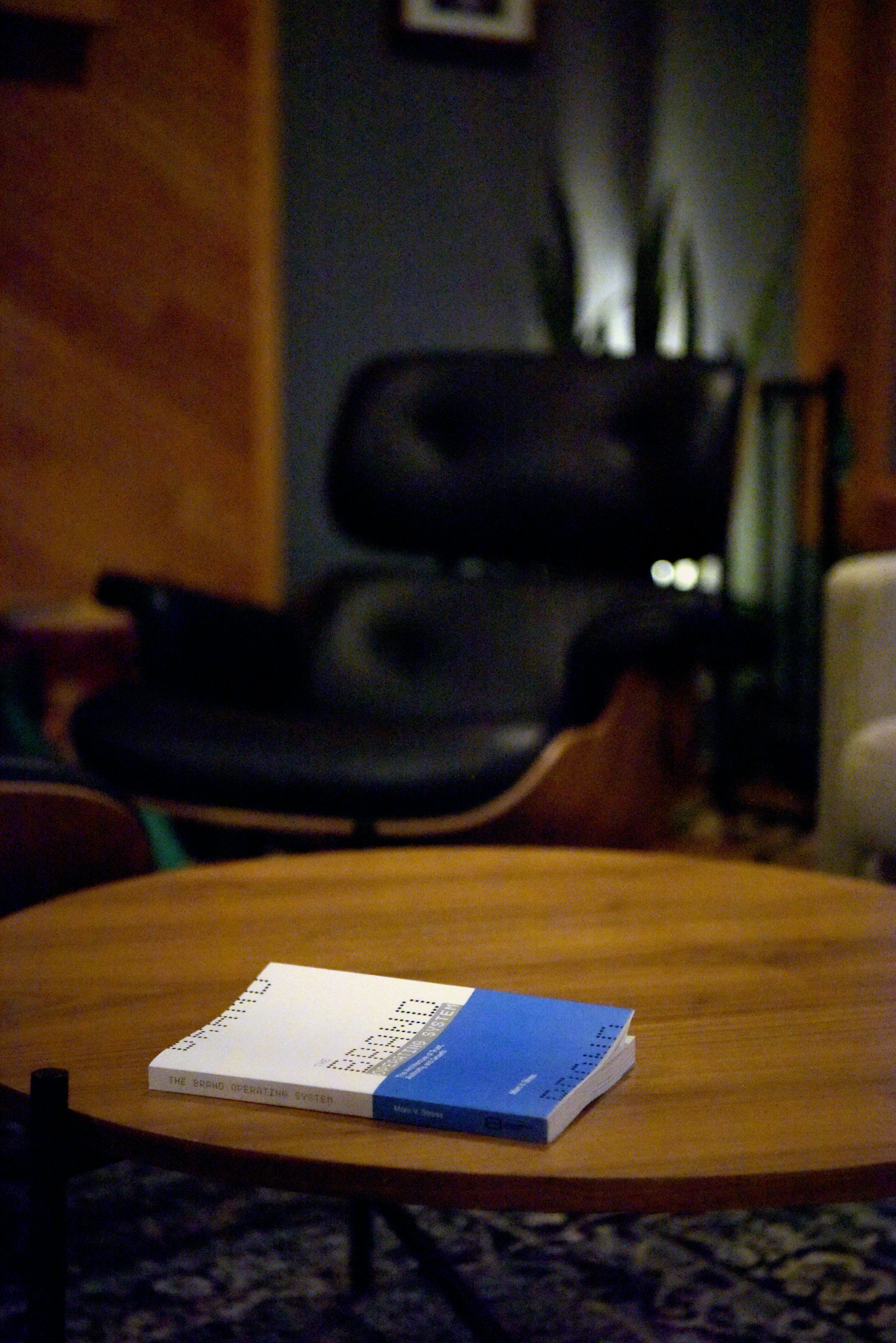 Lo-fi Still Life: A Book on a Wood Table in a Dim Living Room