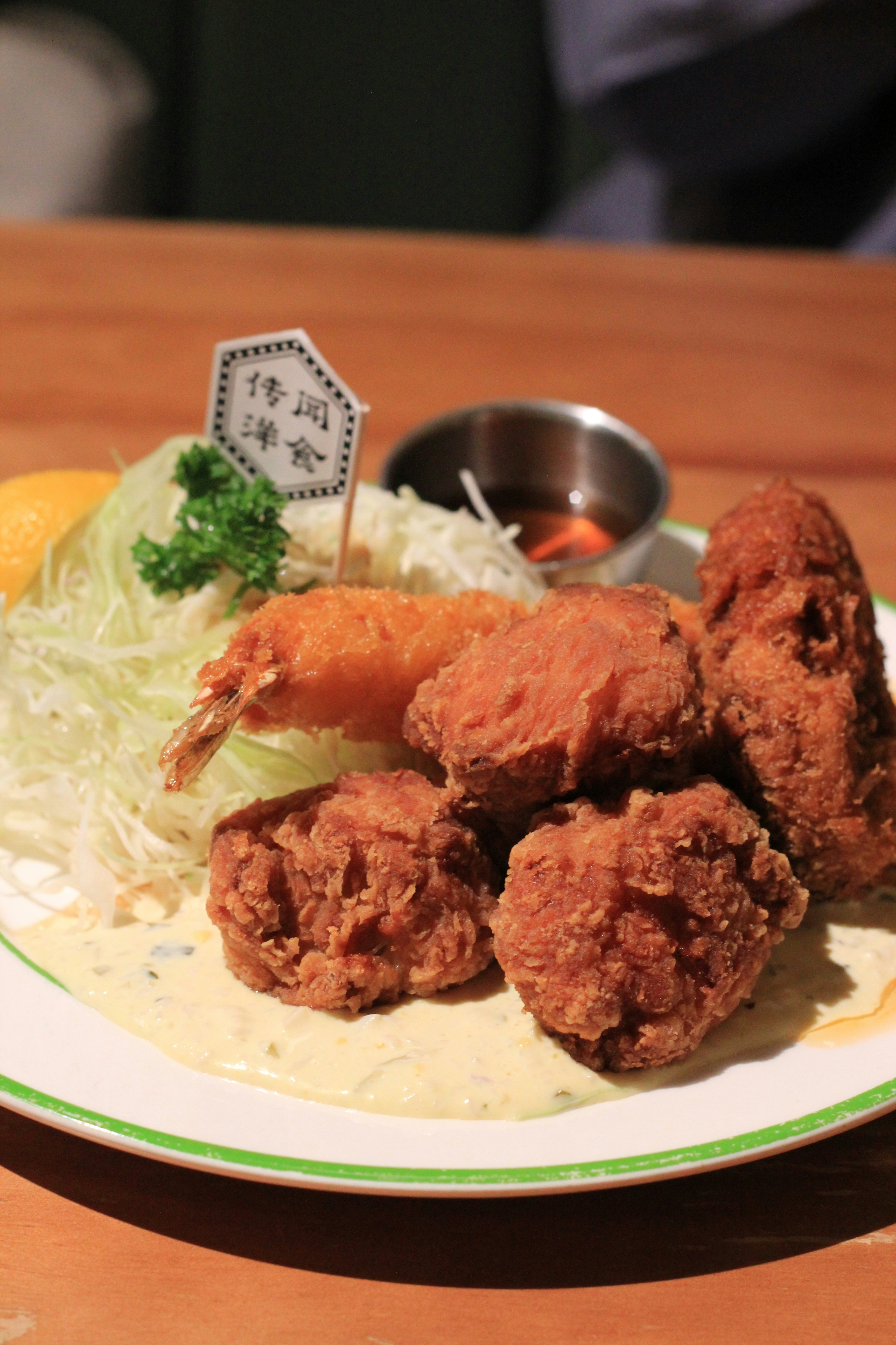 Crispy Karage Quartet with Shredded Cabbage and Lemon Draped on a Creamy Ring