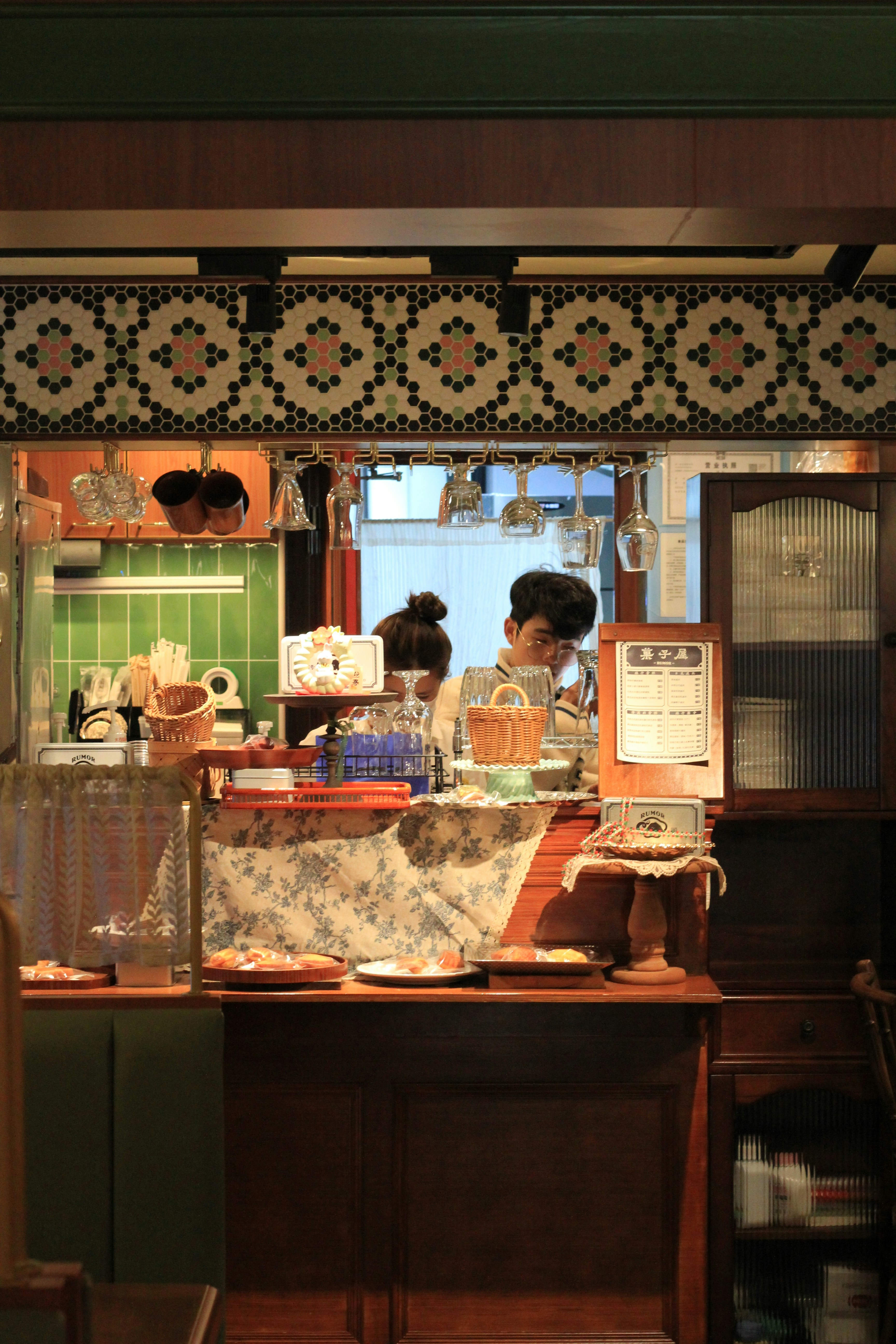 Behind the Counter: Quiet Focus Amid Vintage Kitchen Chic