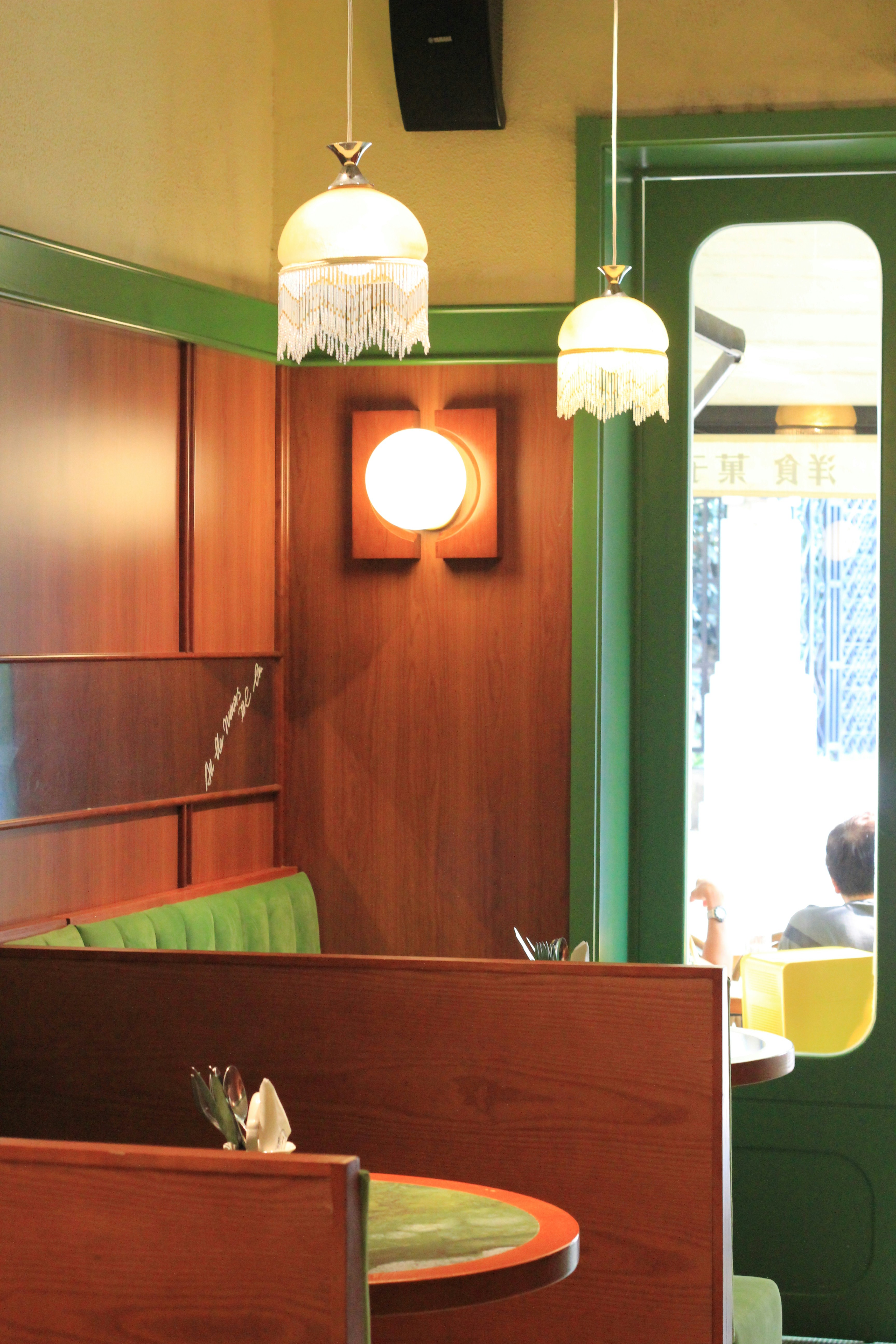 Green Booths and Warm Light in a Cozy Café