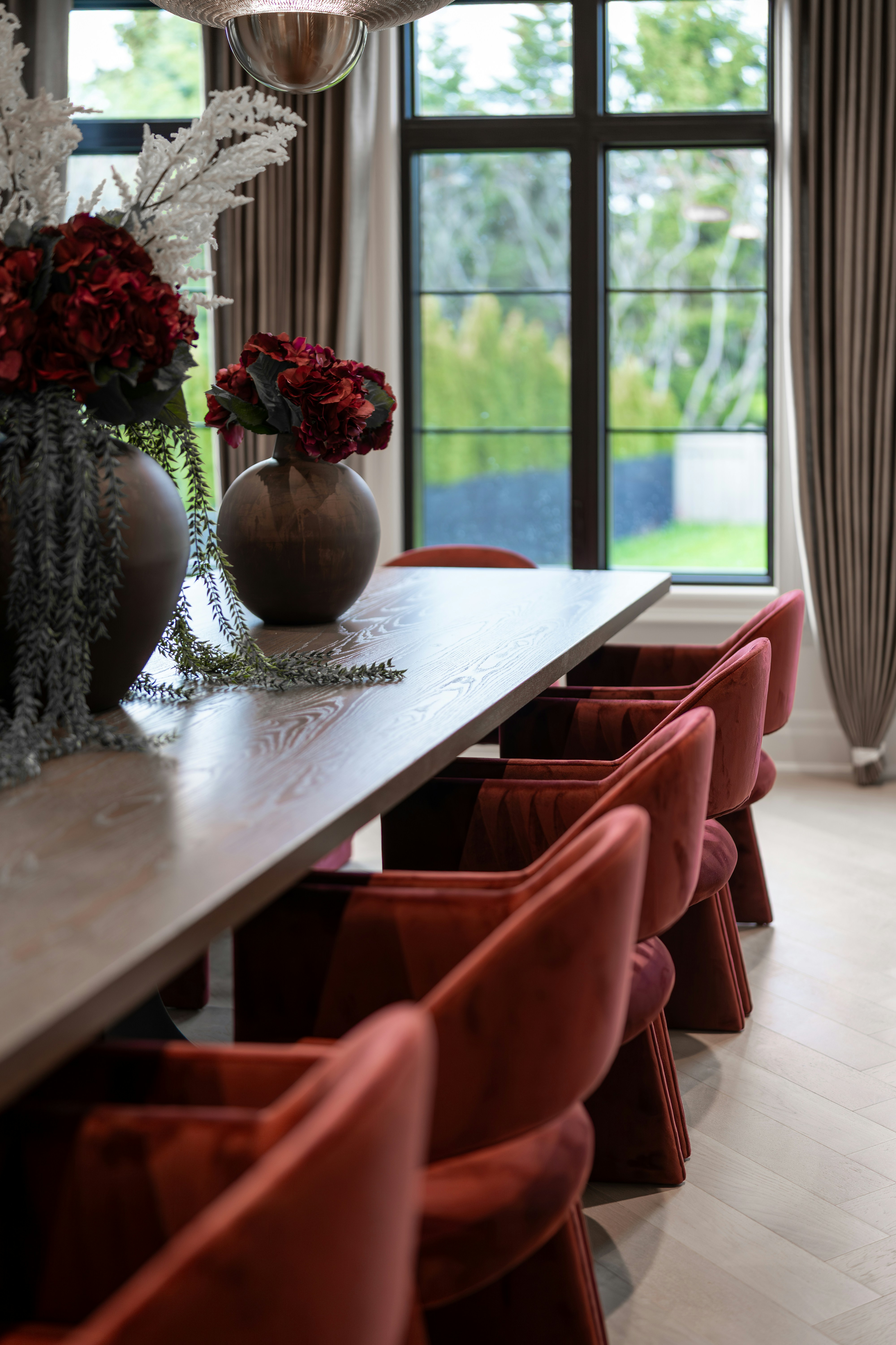 Crimson blooms framing a sunlit dining nook