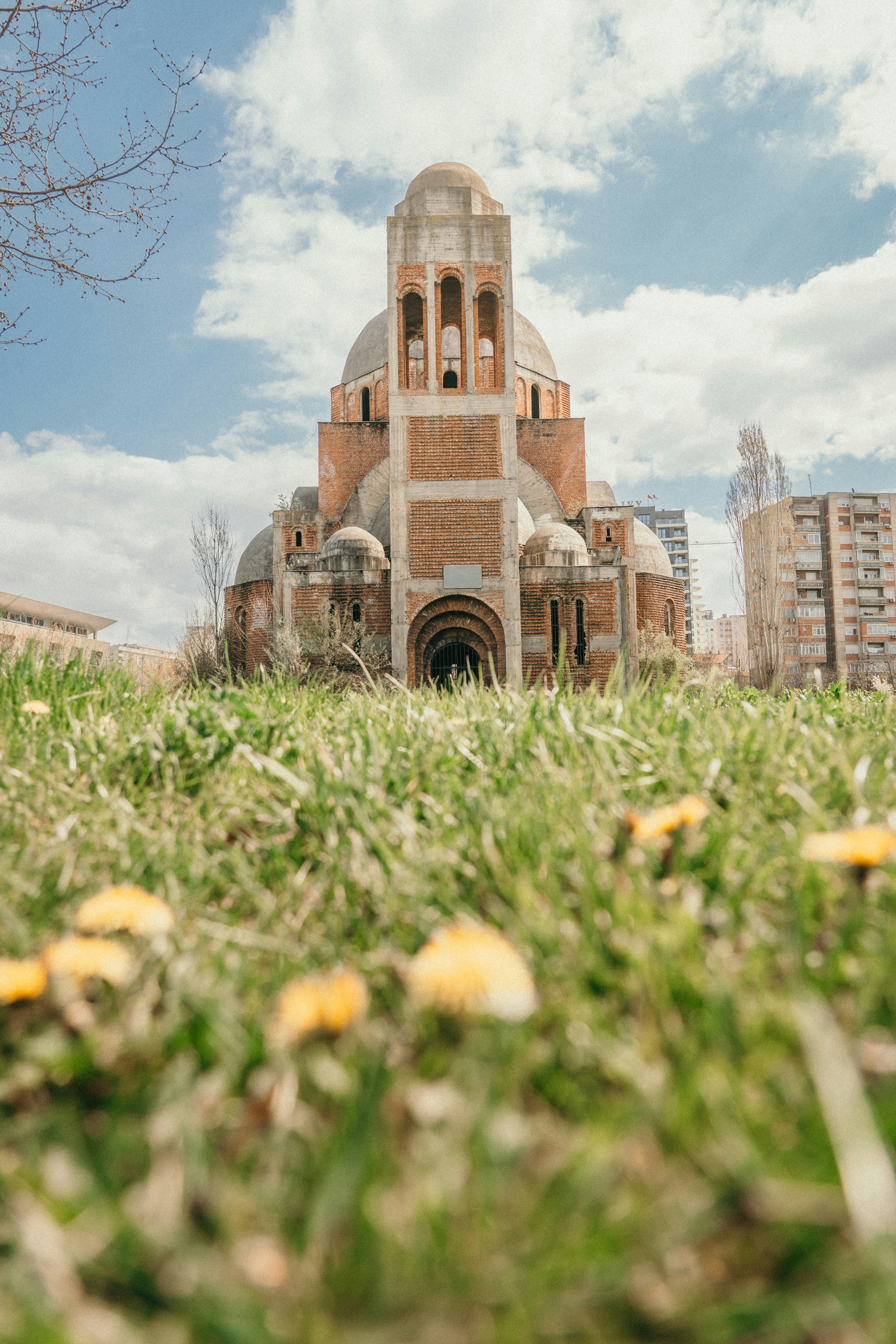 Brick Basilica Rising from Green Field