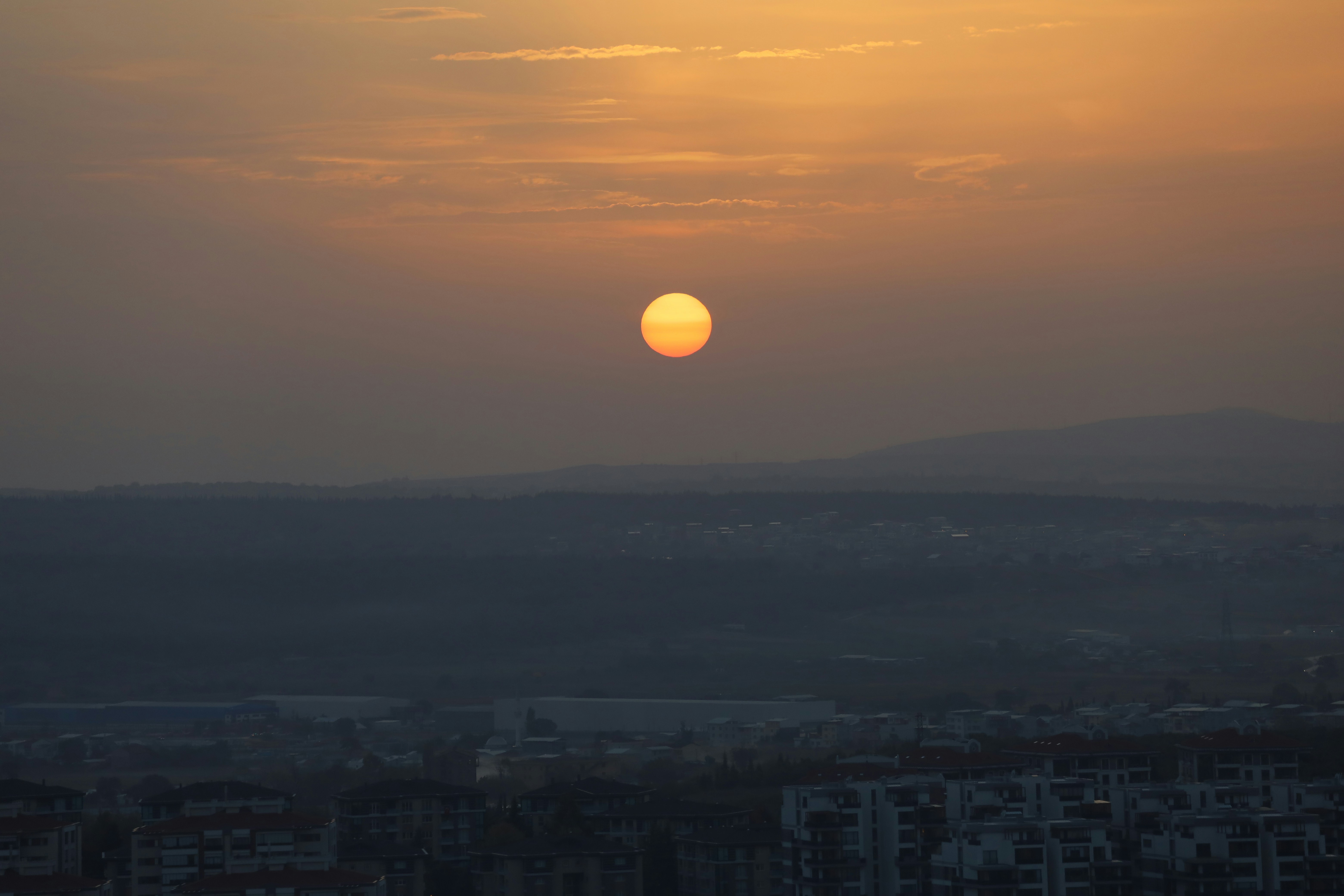 Descent to Dusk: Sun Over a Quiet Valley