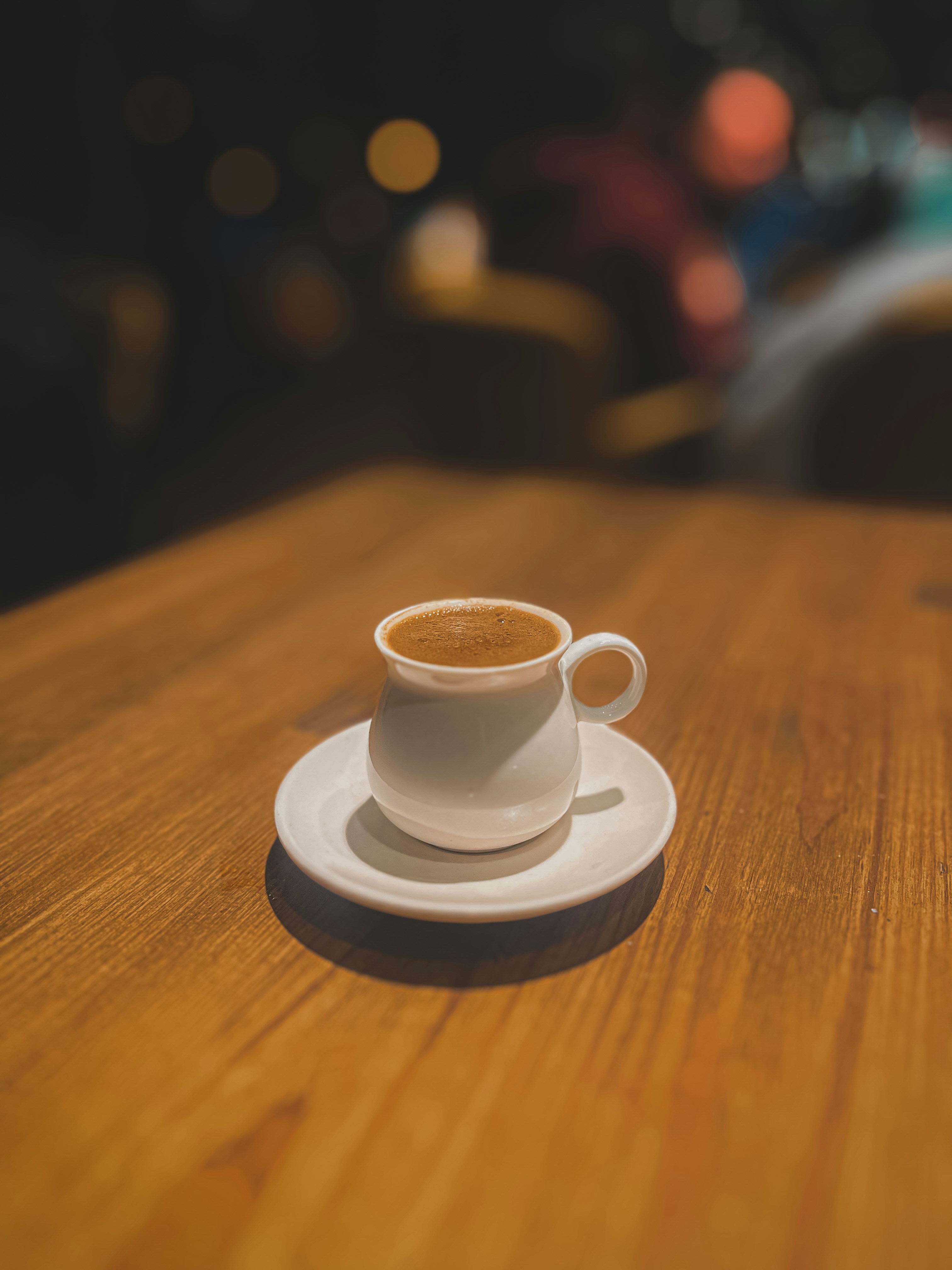 Steam and Spotlight: A Ceramic Cup on a Wooden Stage