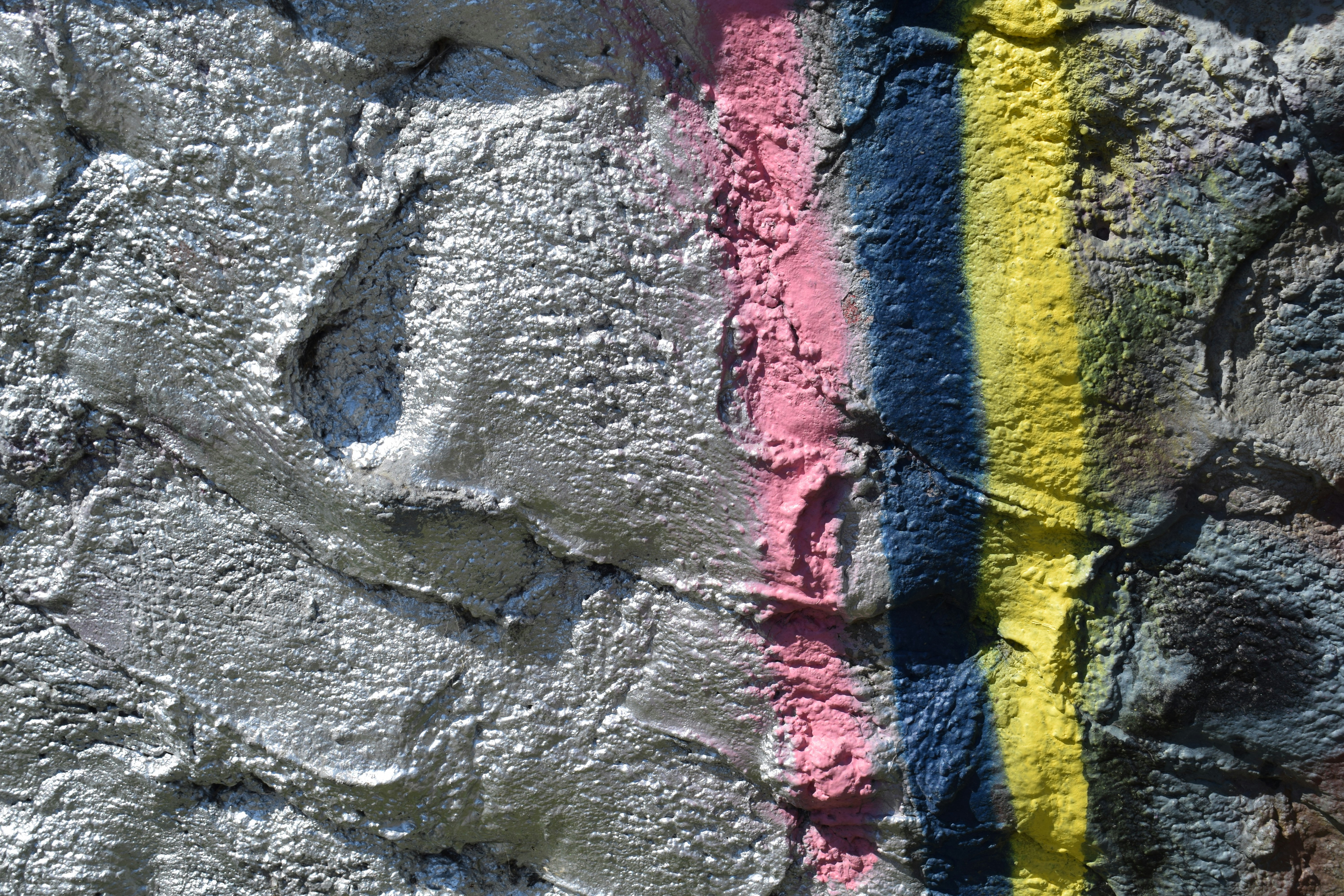 Colorful Chalk Veins Across a Weathered Wall
