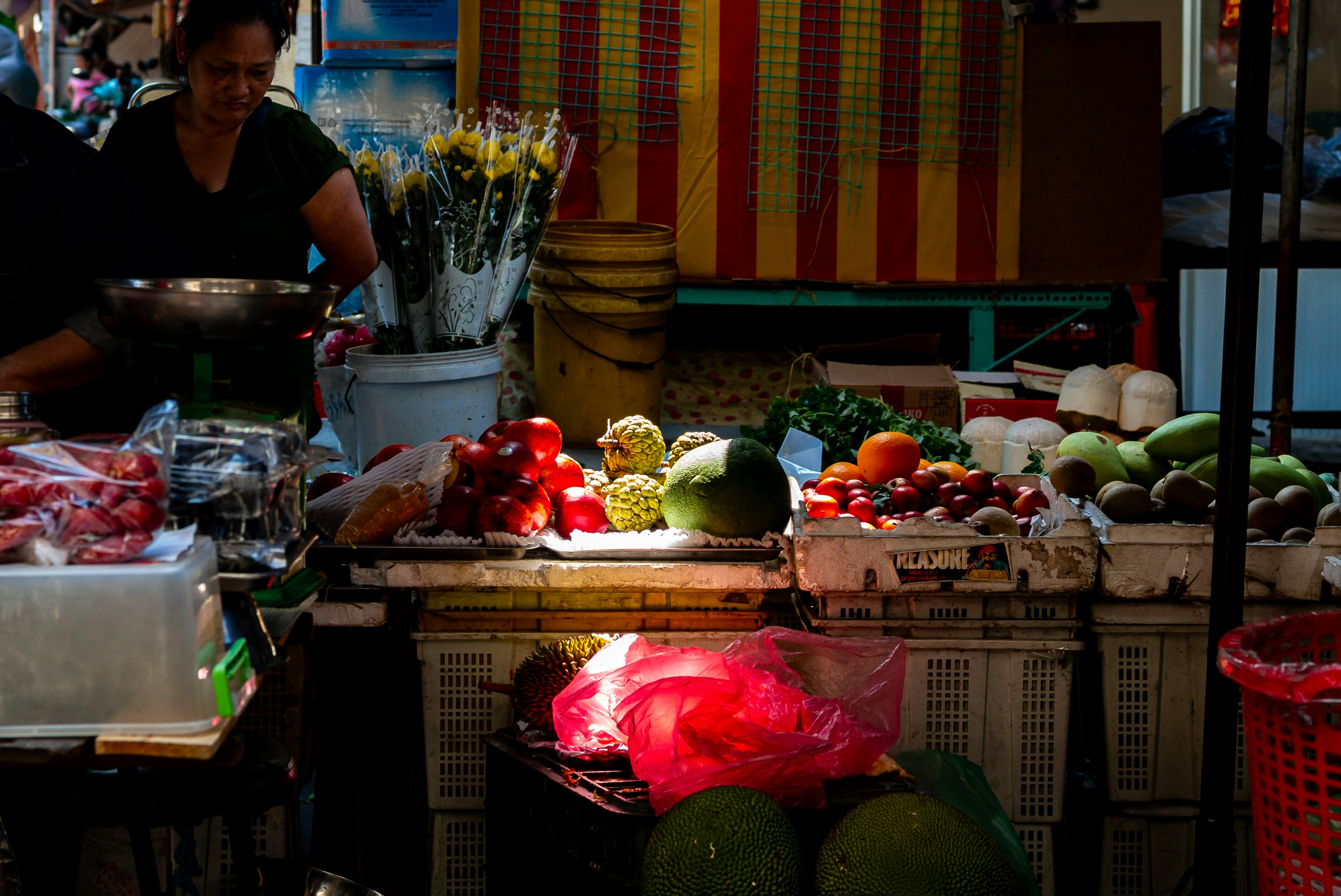 Market Vendor Framing: Colorful Produce Under Subtle Drama