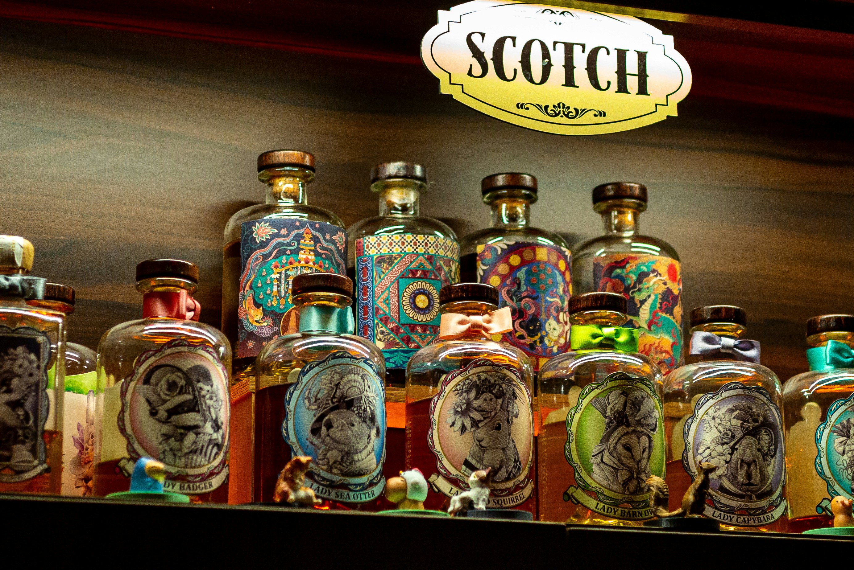 Spirited Spirits: Vintage Bottles Align Beneath a Scotch Label Display