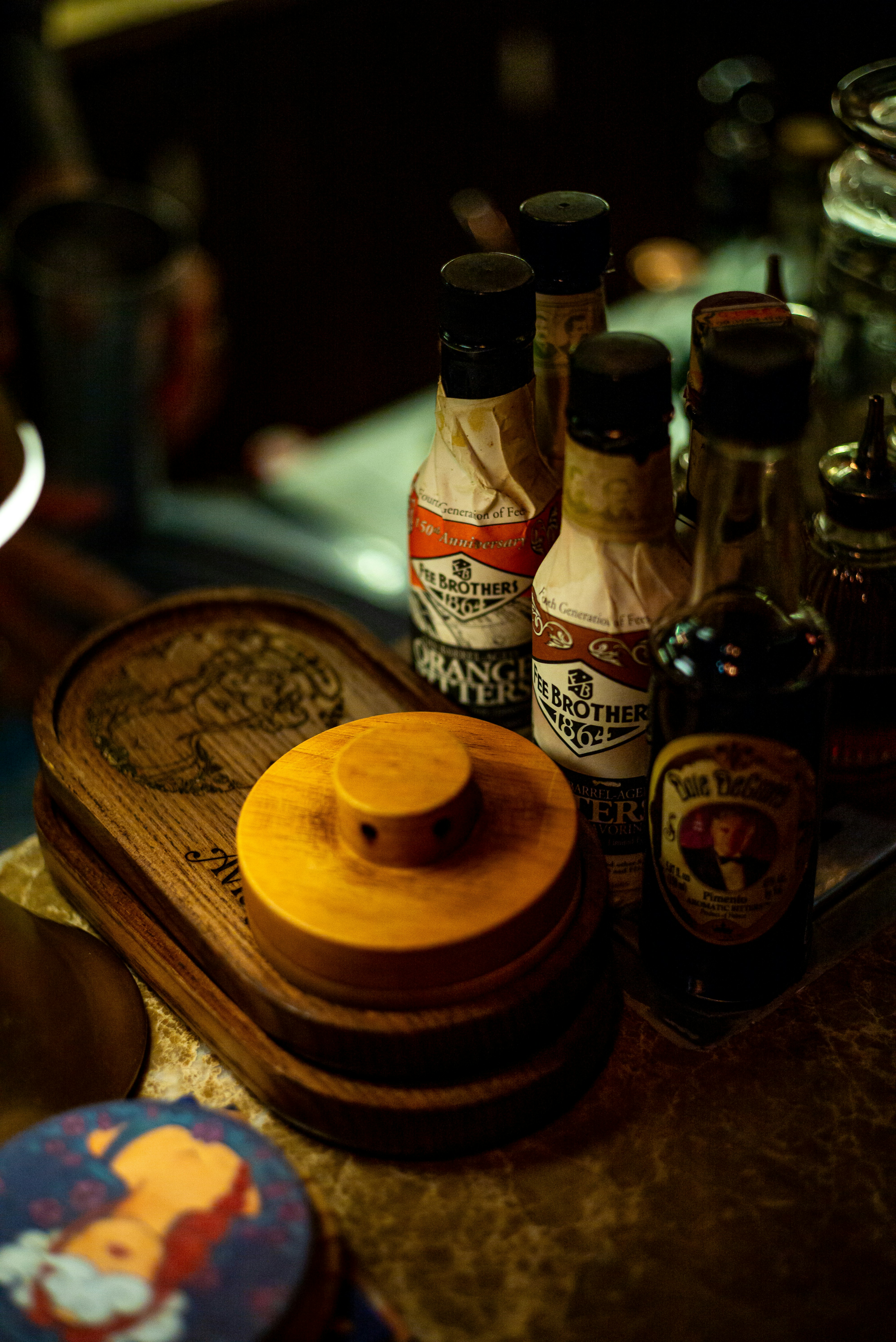Amber Bottles and Wooden Keeper on a Rustic Bar Counter