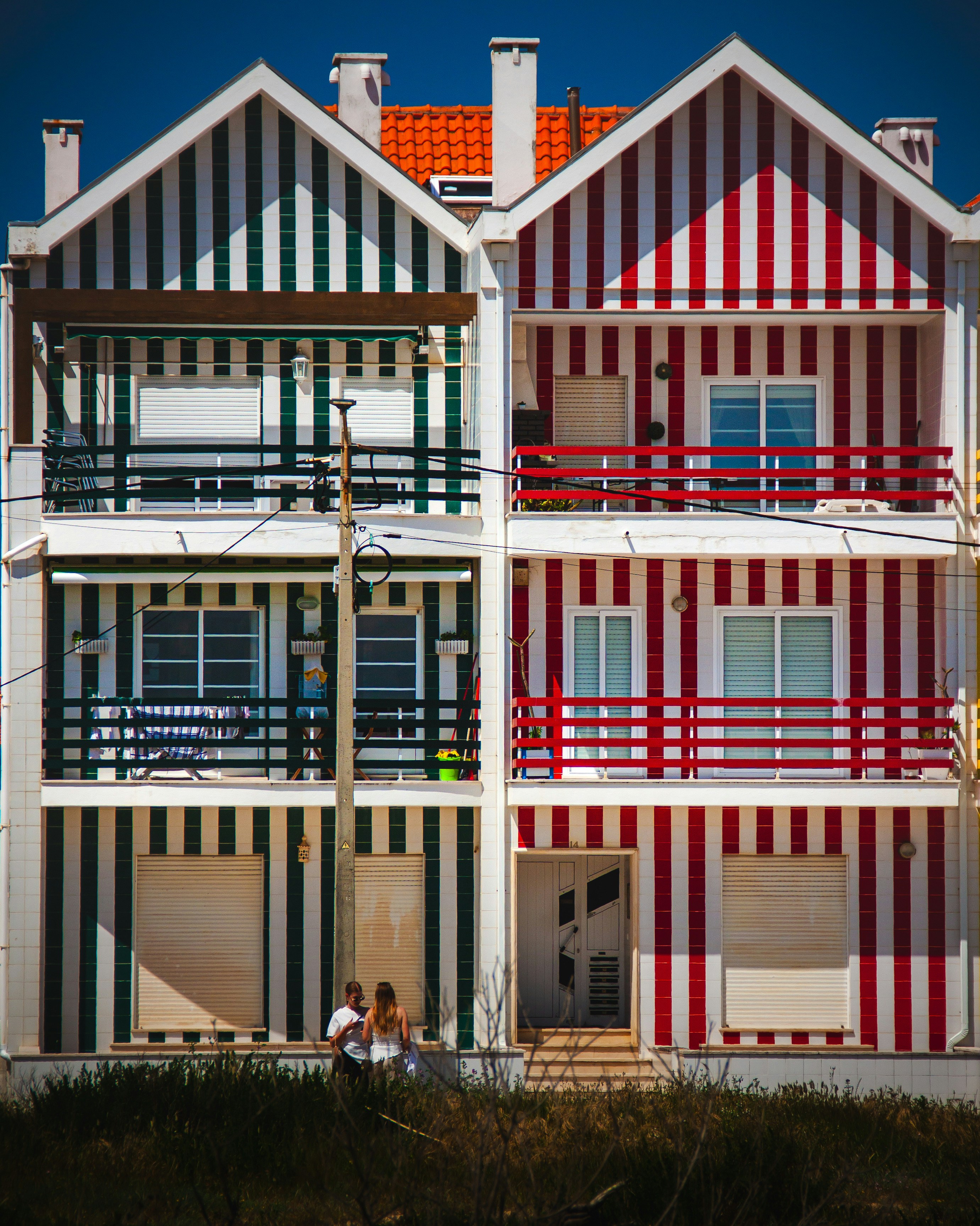 Striped Houses at Dusk: A Pair of Coastal Rowhouses