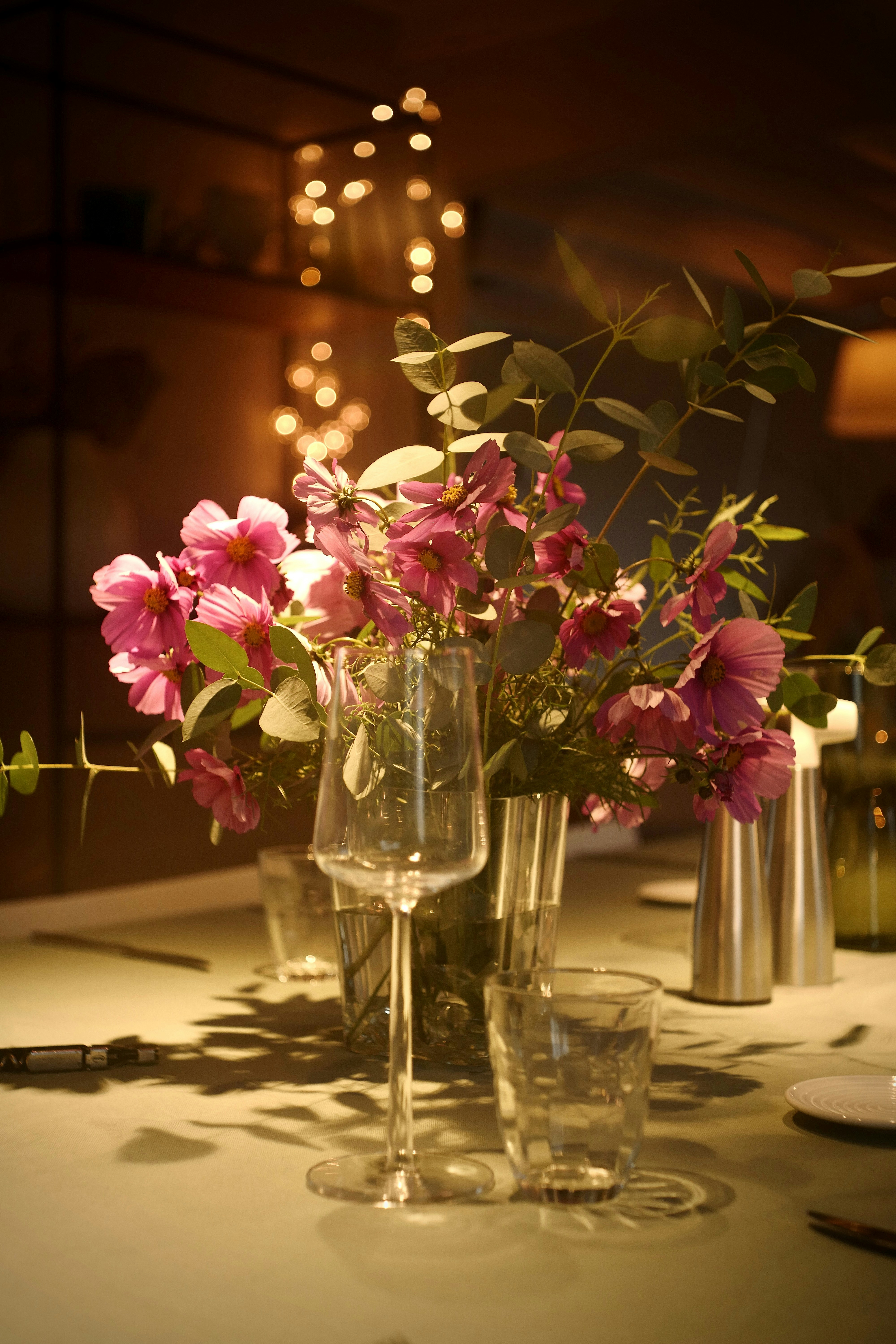 Evening Bouquet: Warm Light caresses a centerpiece of pink hollyhocks