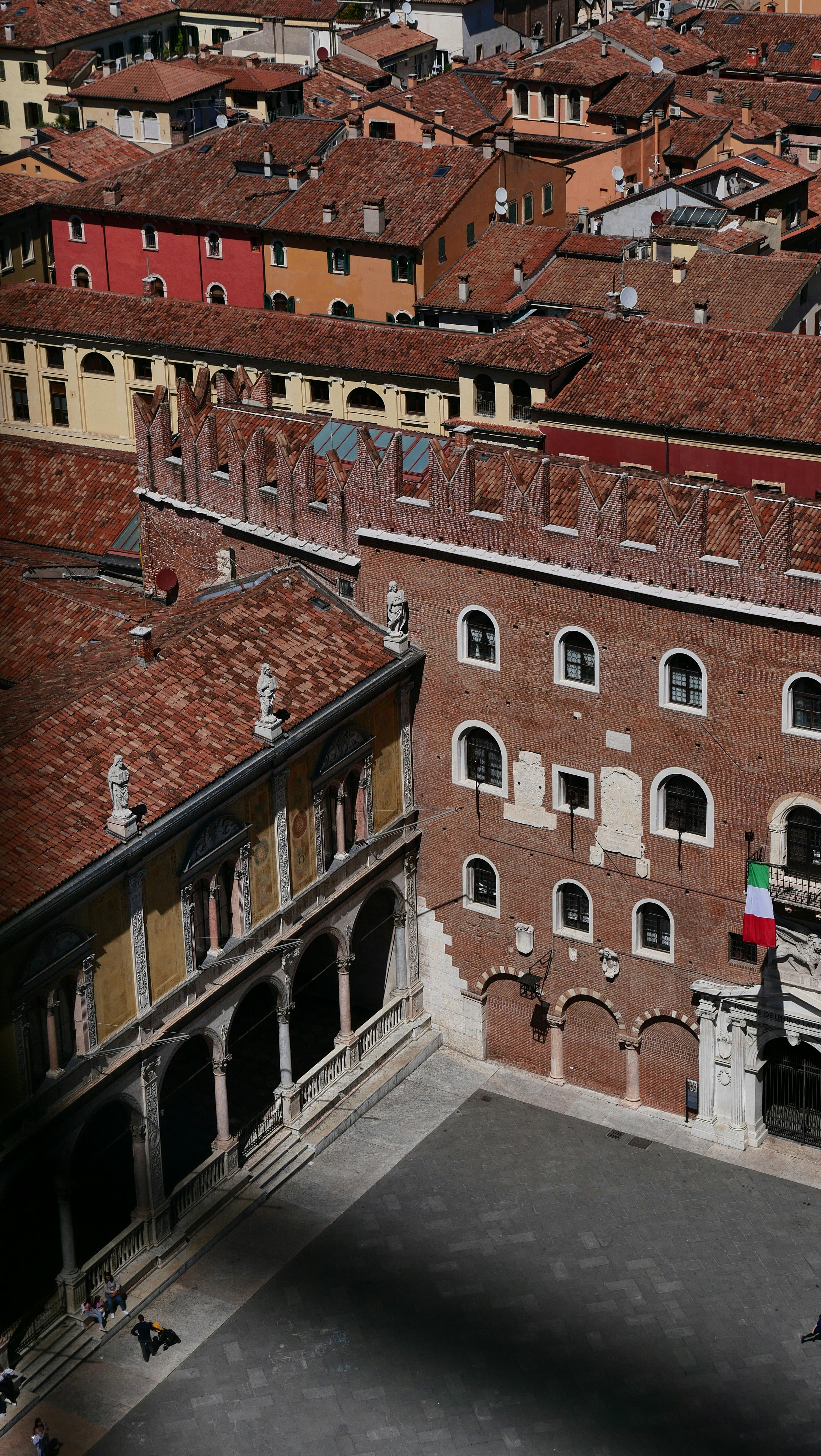 Terracotta Rooftops and Sunlit Facades: A Venetian-Style Alleyway from Above